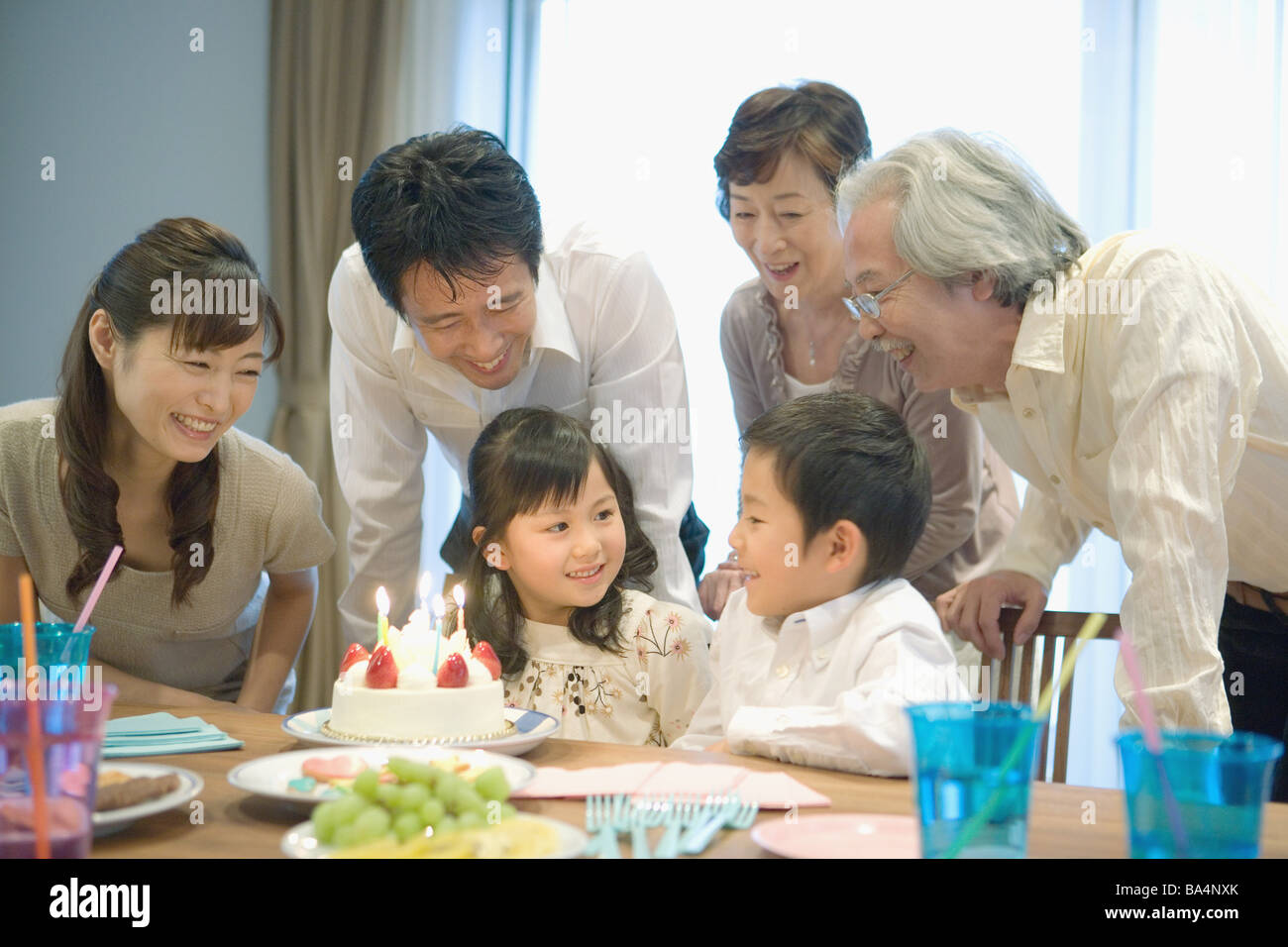 Three generation family celebrating birthday at home Stock Photo - Alamy