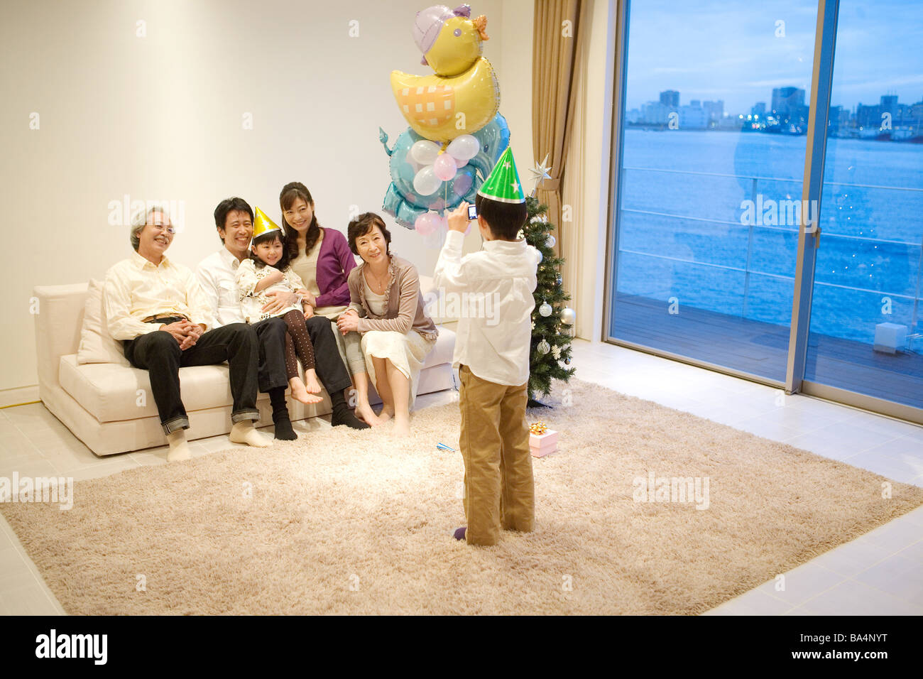Child taking snap of his family Stock Photo - Alamy