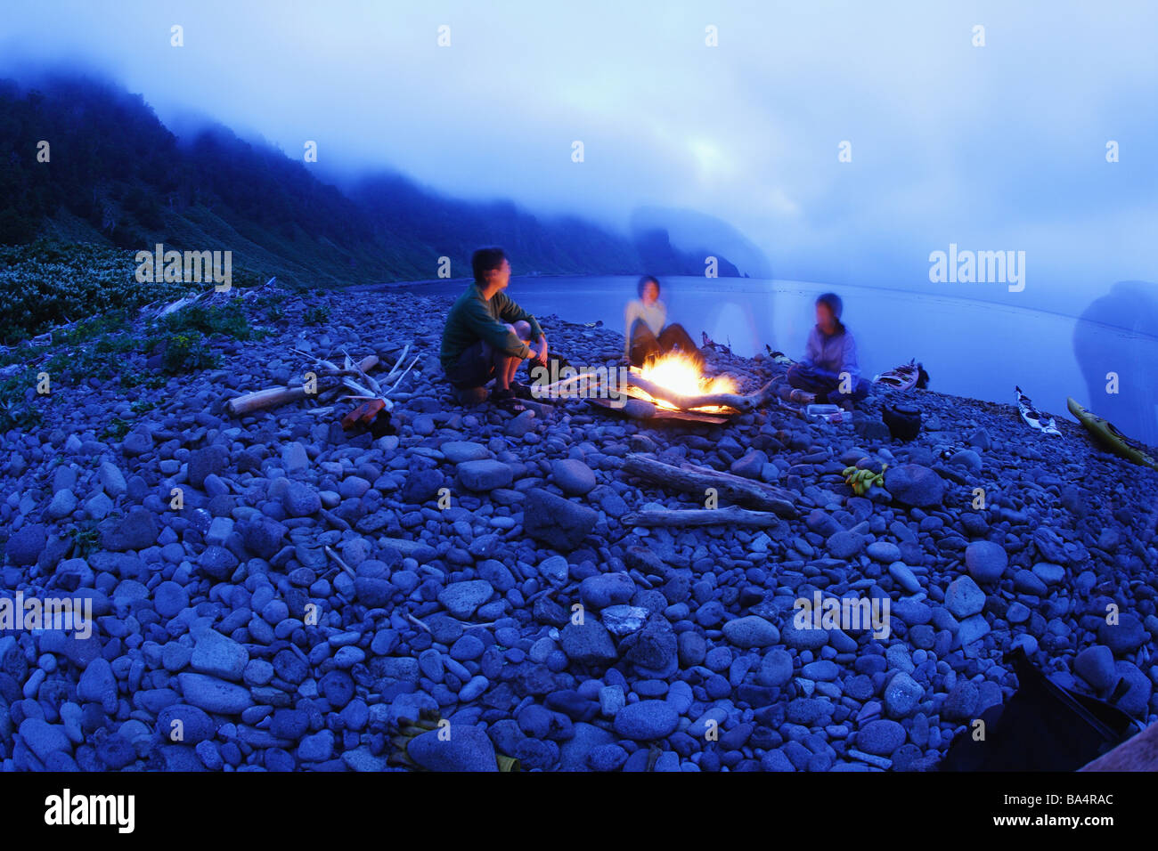 People Sitting Around Bonfire on Beach Stock Photo - Alamy