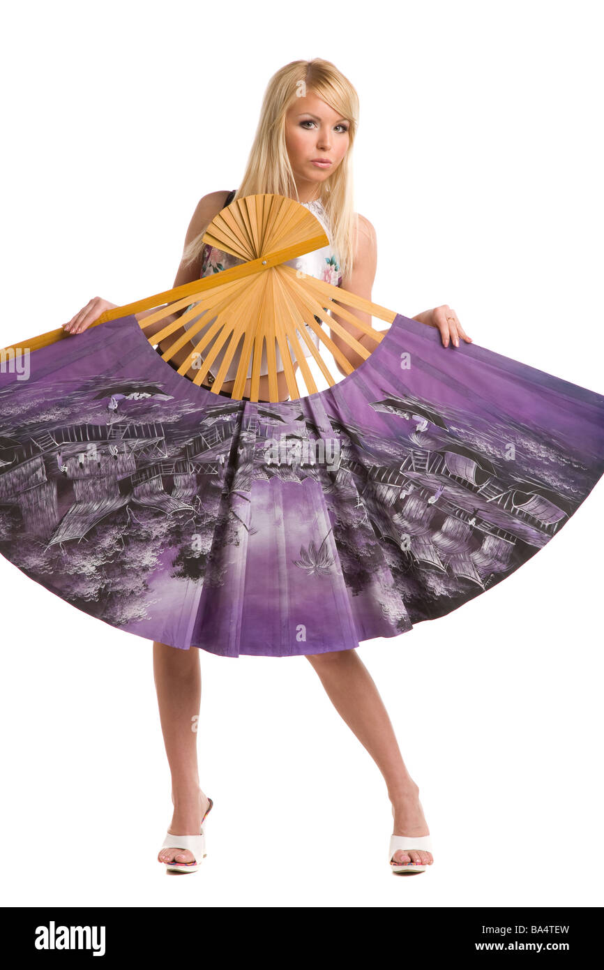 blond woman with large fan on a white background Stock Photo - Alamy