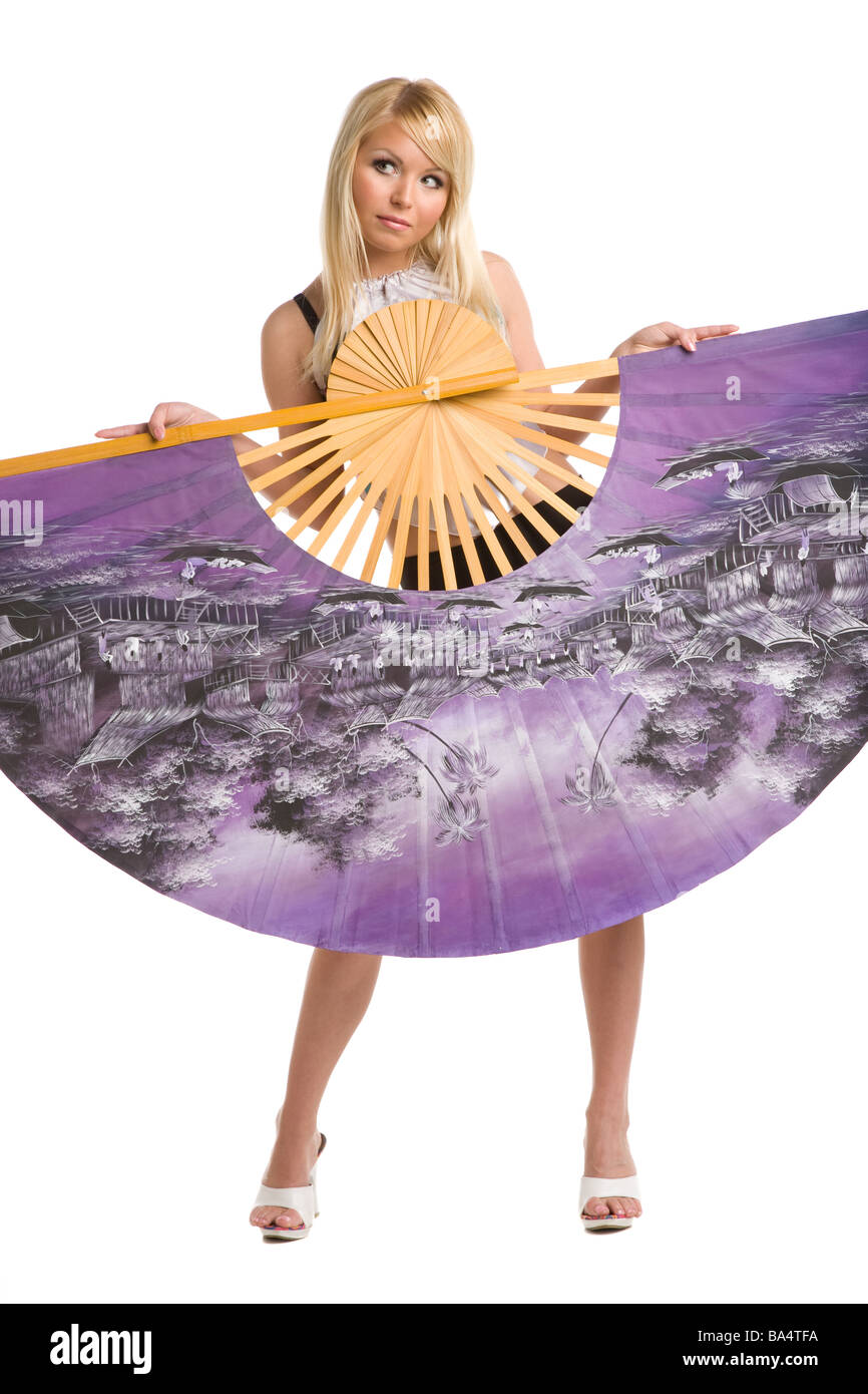blond woman with large fan on a white background Stock Photo - Alamy