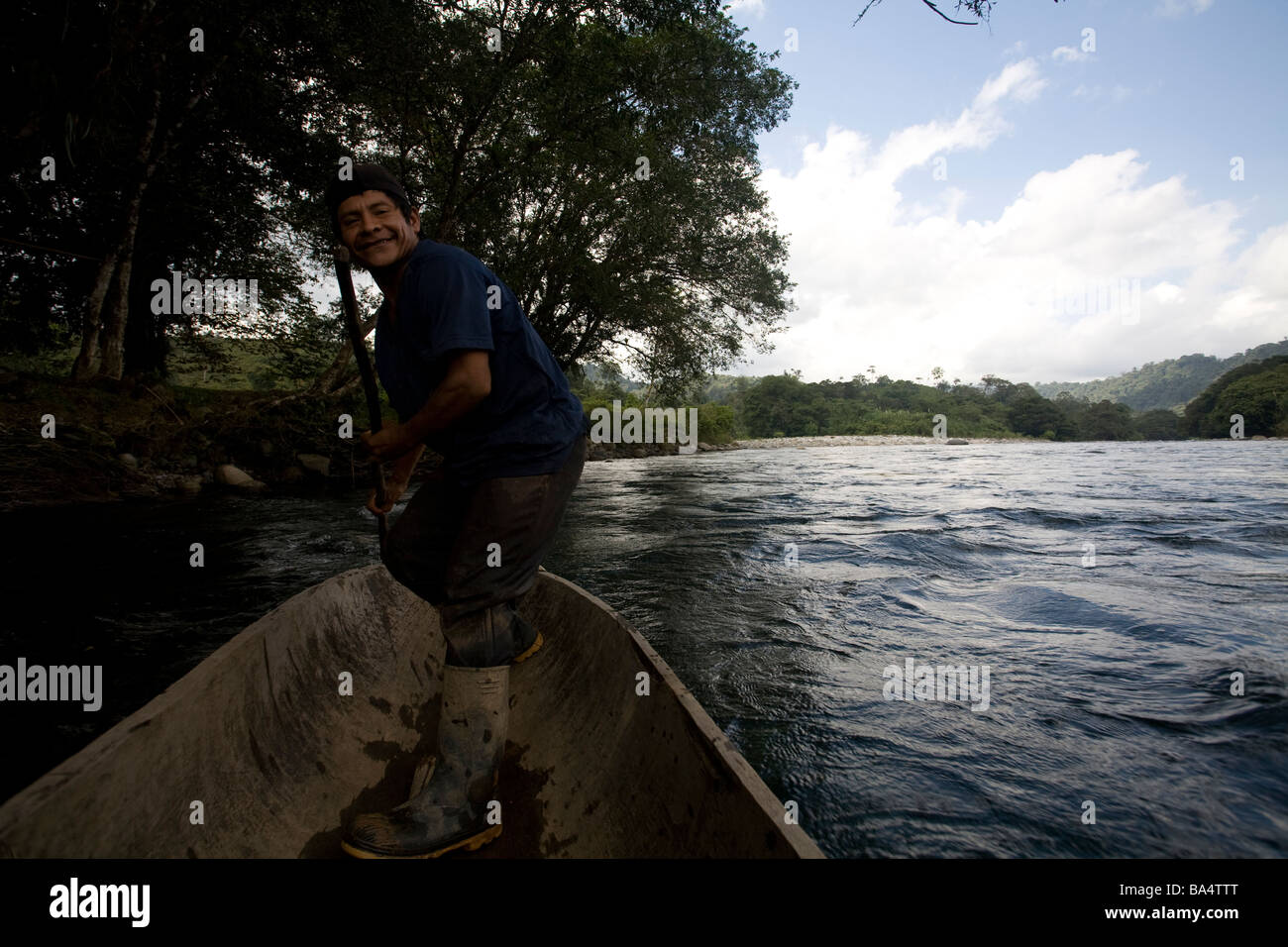 Man crossing river in small boat Stock Photo - Alamy
