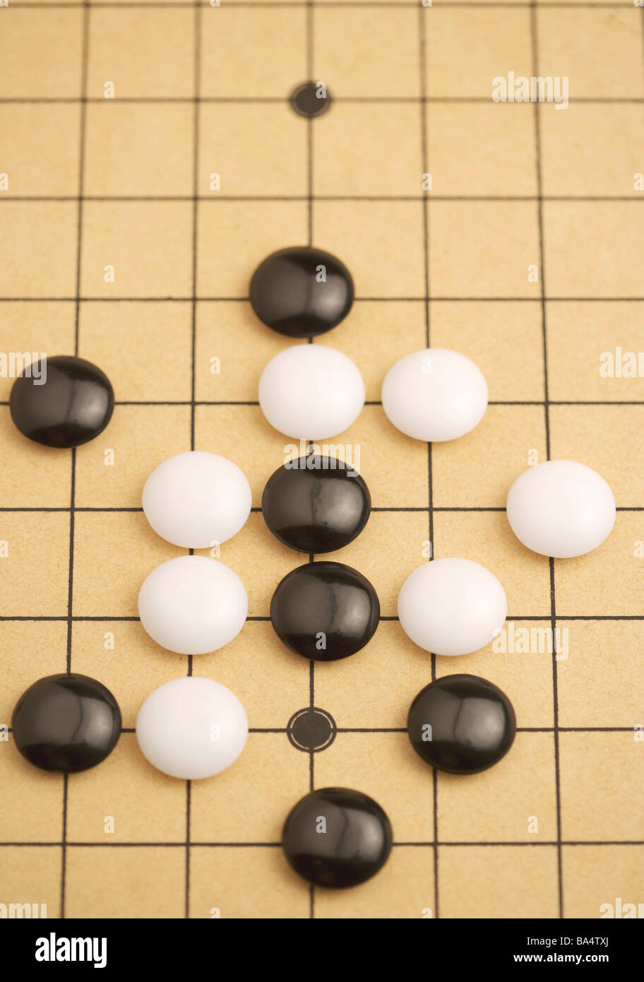 Go board with chess pieces Stock Photo - Alamy