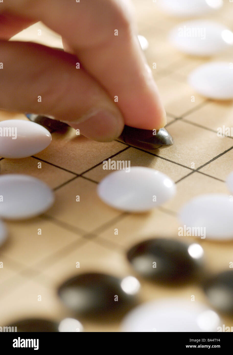Man playing Go at Go board Stock Photo - Alamy