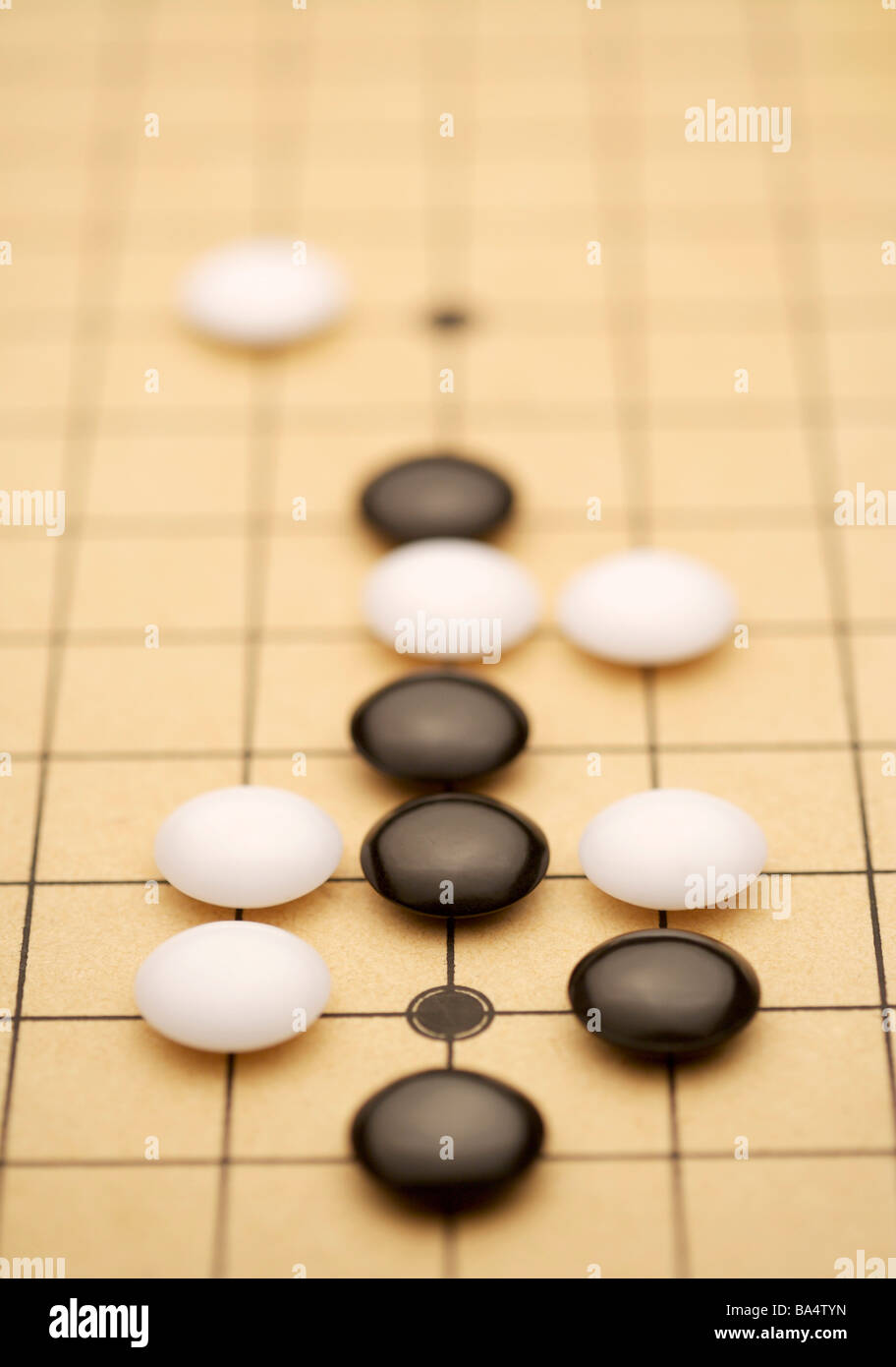 Go board with chess pieces Stock Photo - Alamy