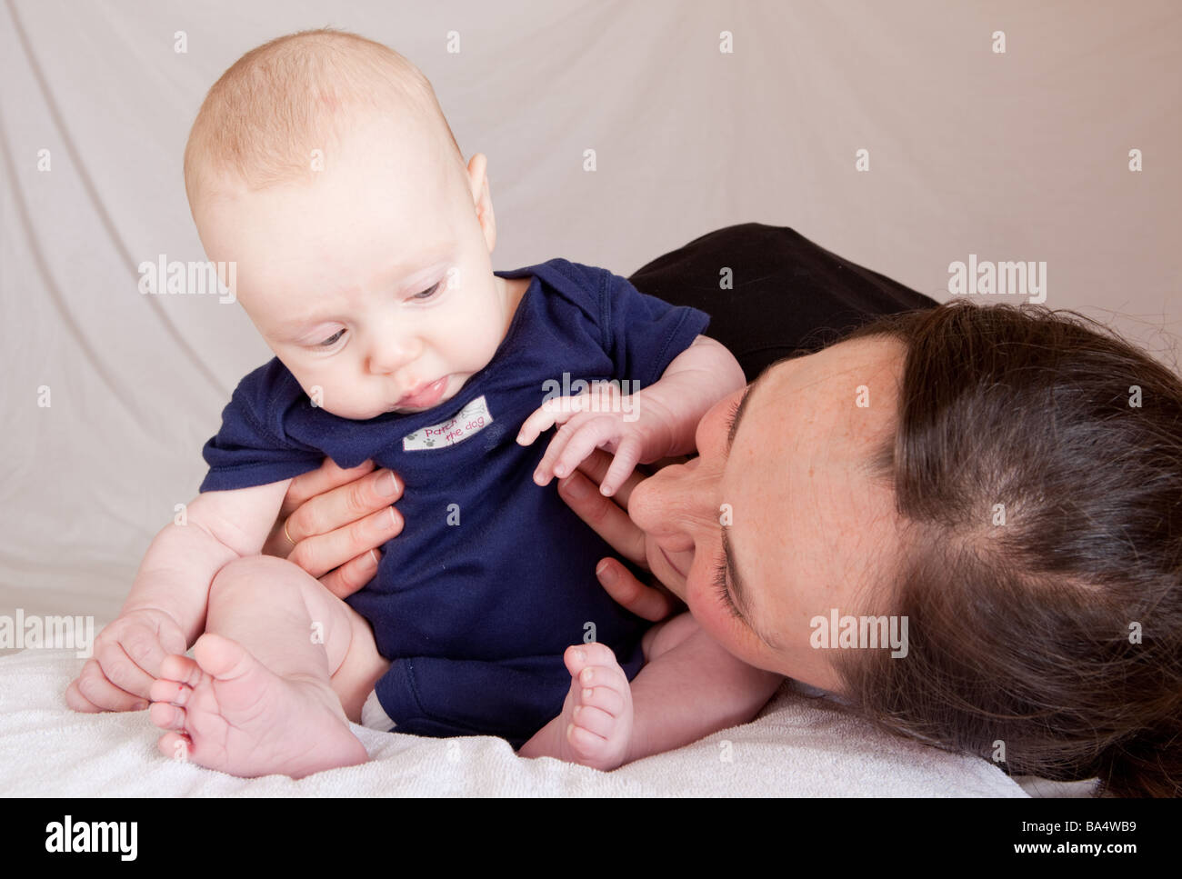 Mother and newborn baby three 3 months old playing interacting together ...