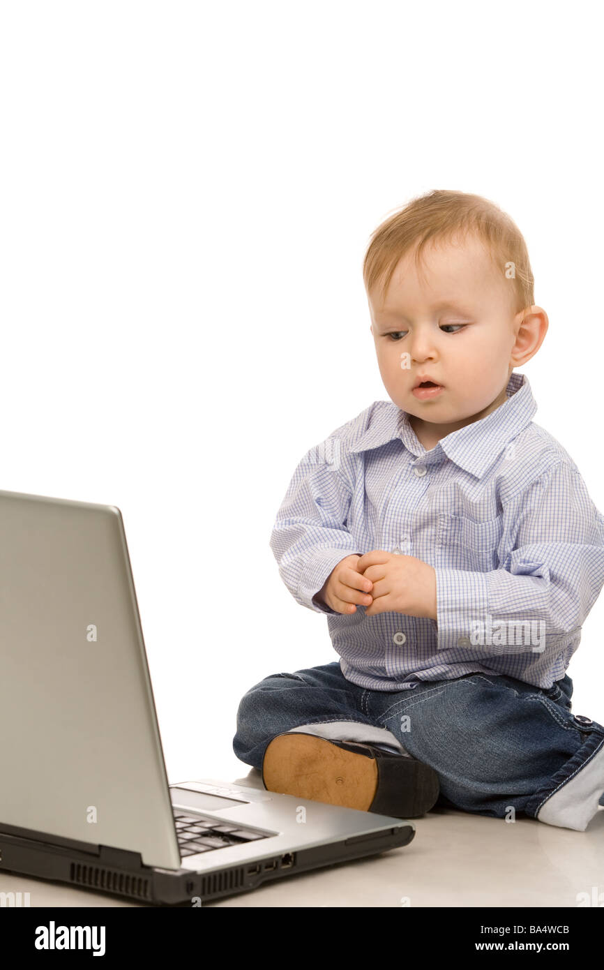 small boy play with laptop on a white background Stock Photo - Alamy