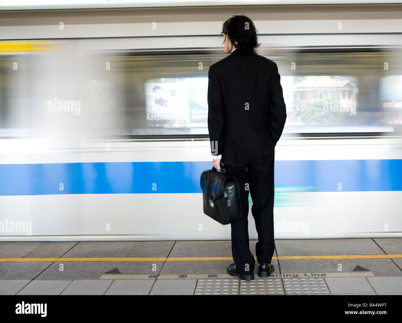 Businessman waiting on subway platform hi-res stock photography and ...