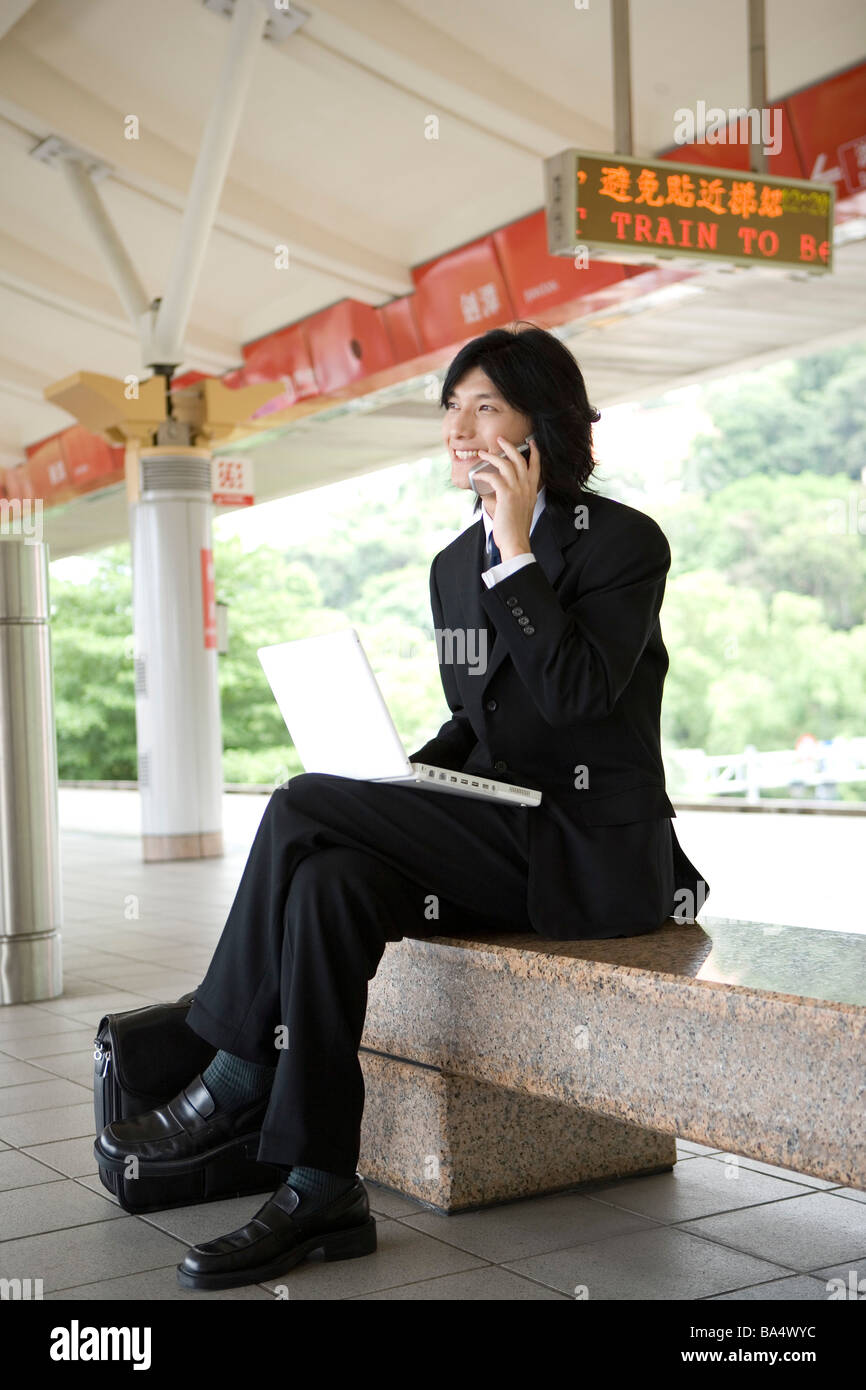 Businessman sitting on bench platform hi-res stock photography and ...