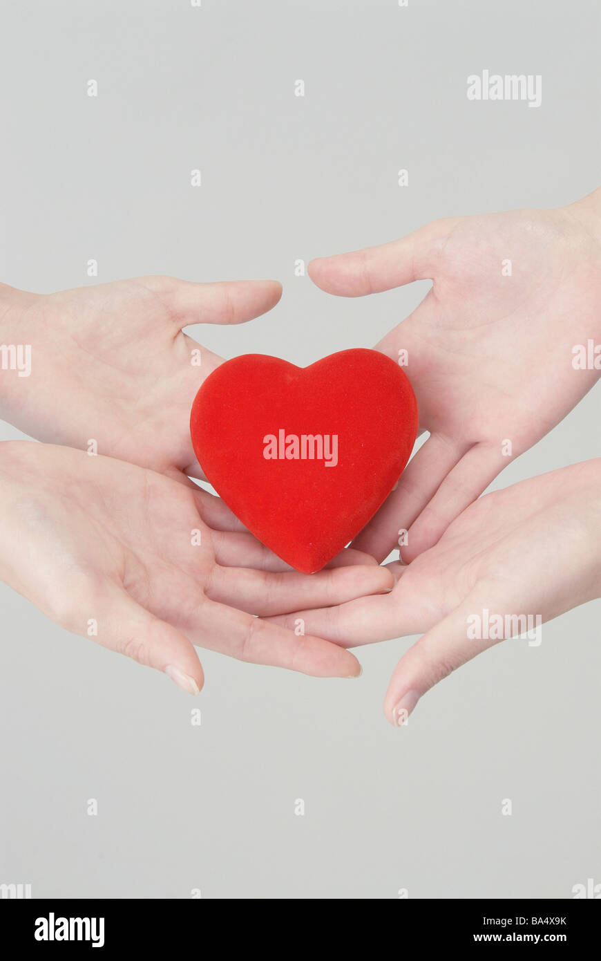 One heart with two hands hi-res stock photography and images - Alamy