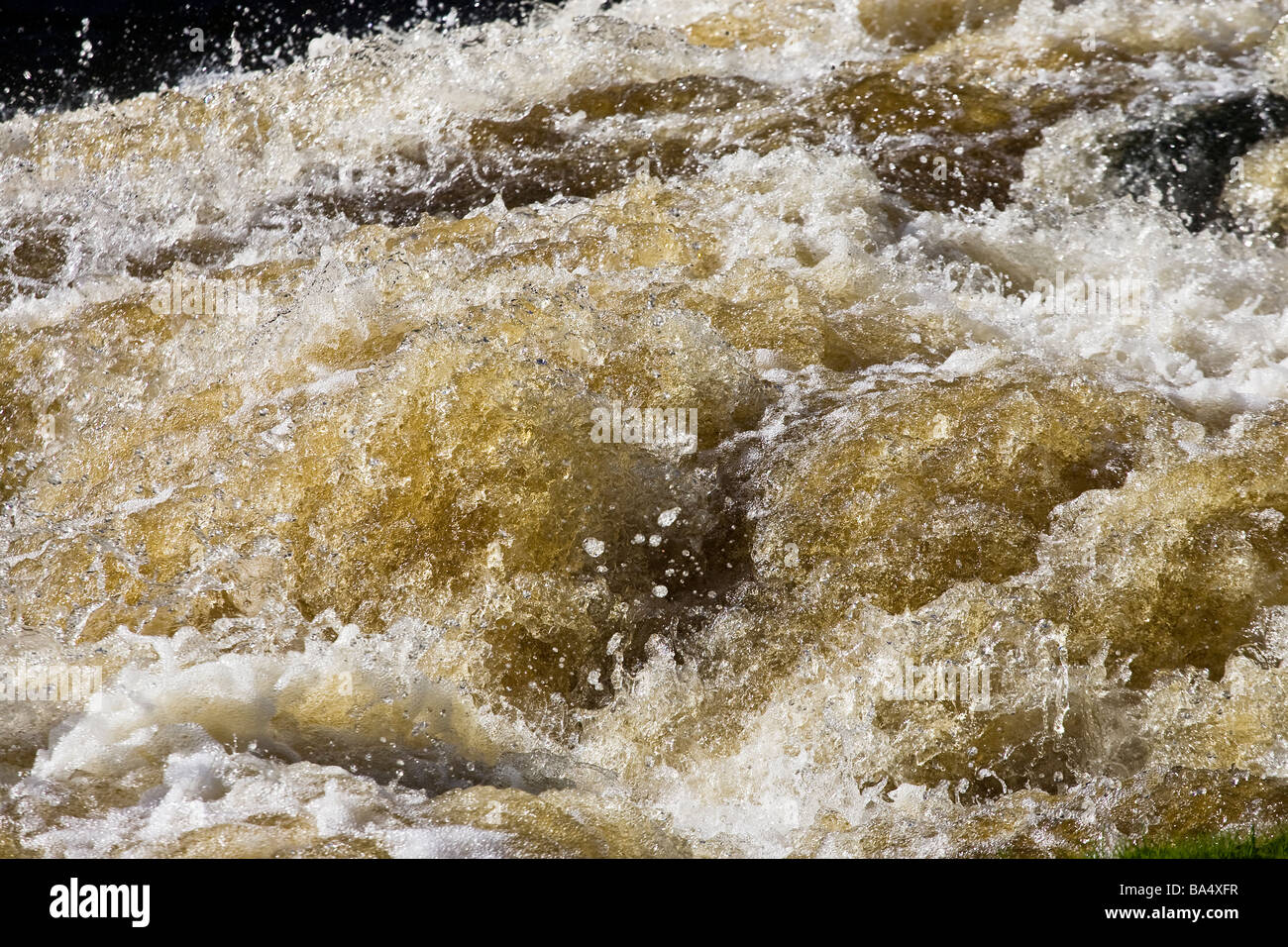 Fast flowing white water rushing down a river Stock Photo - Alamy