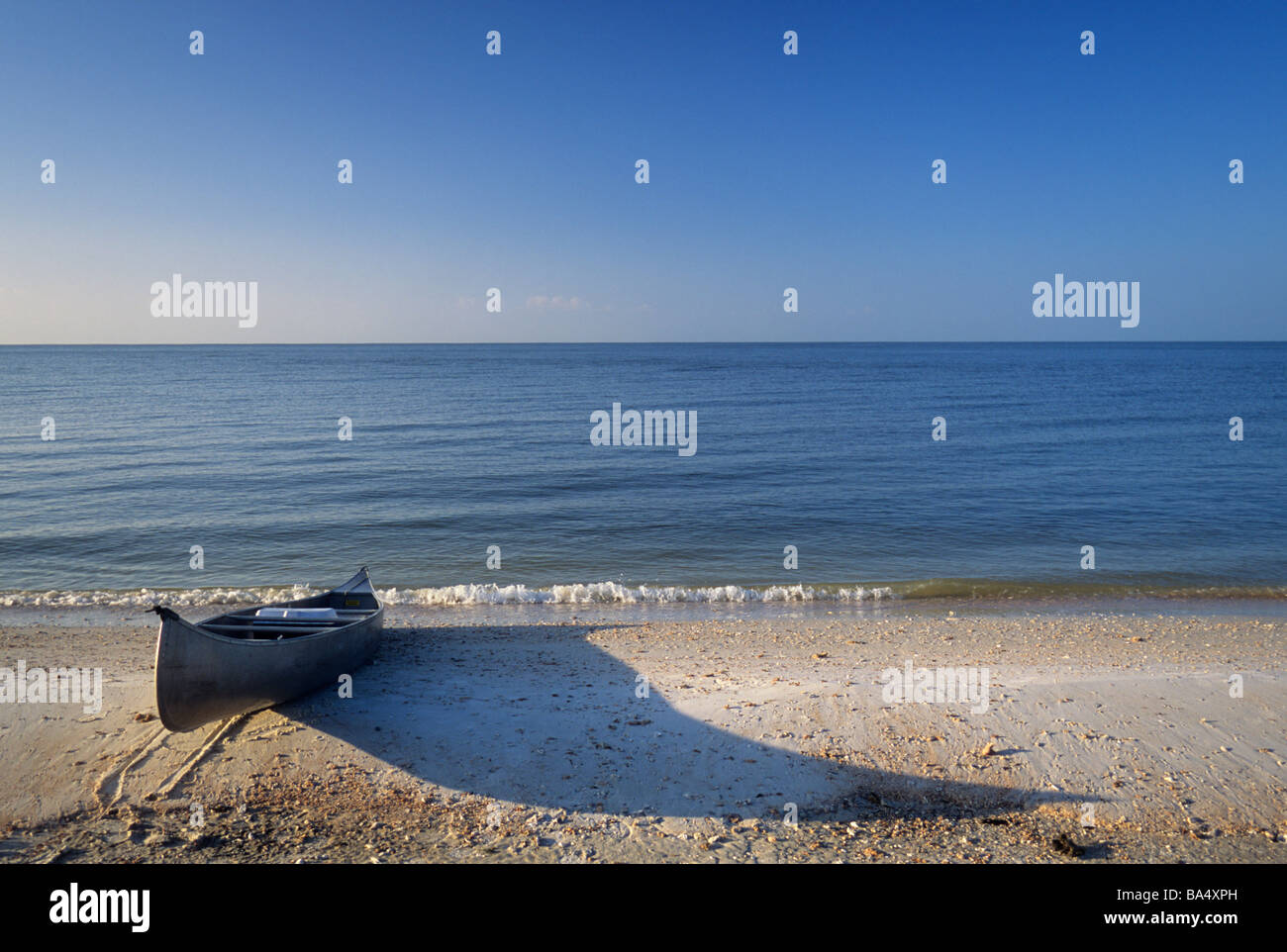 Canoe on beach at sunrise at Picnic Key in Ten Thousand Islands area of ...