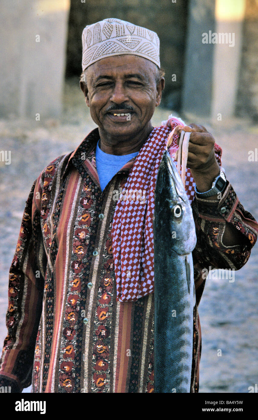 Yemeni Man Wearing Islamic Hat Returning from Market with a Large Fish ...