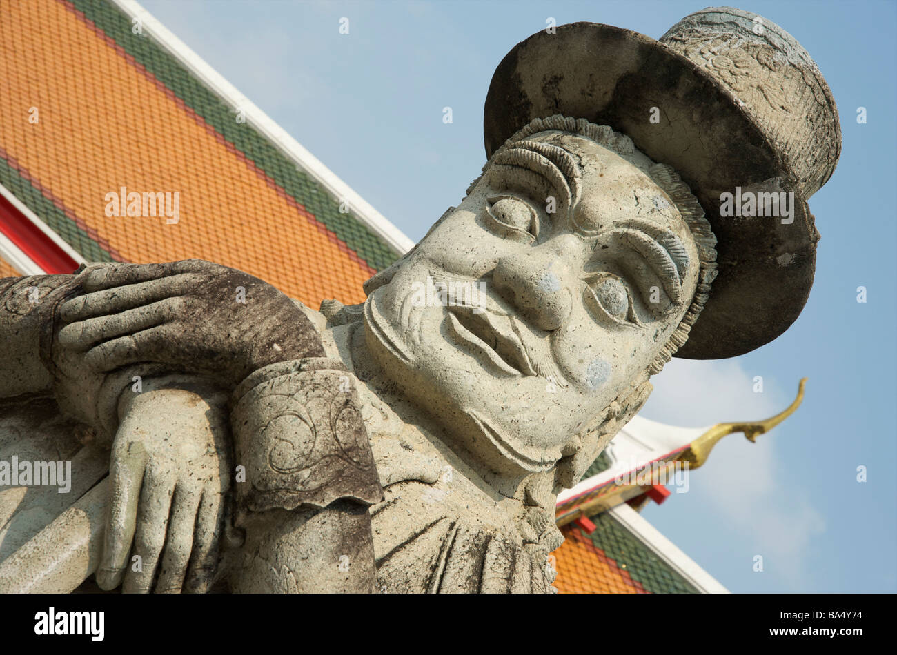 Angled view of a huge stone statue of a European in the grounds of Wat ...