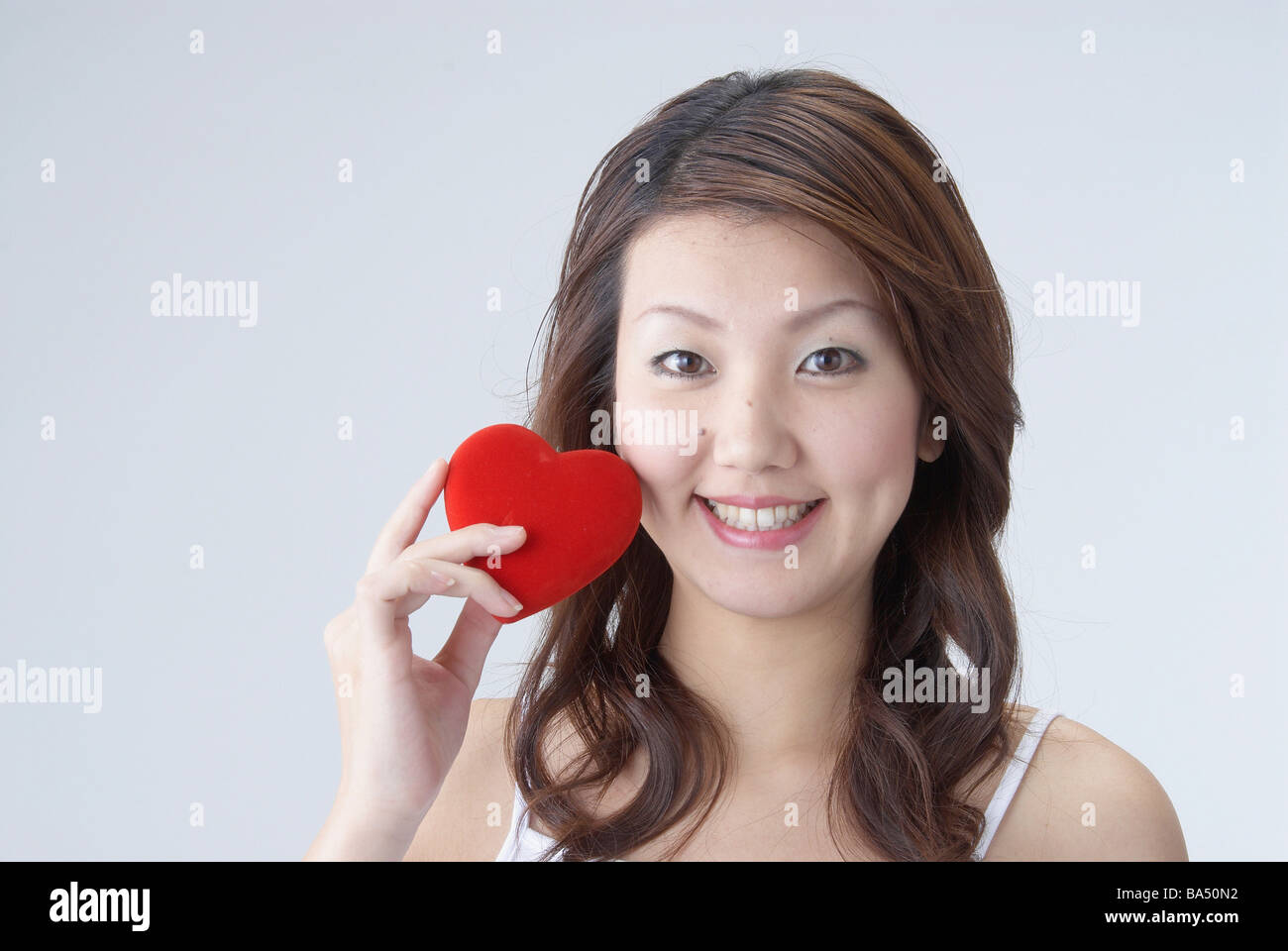 Young Woman Holding Heart Stock Photo - Alamy