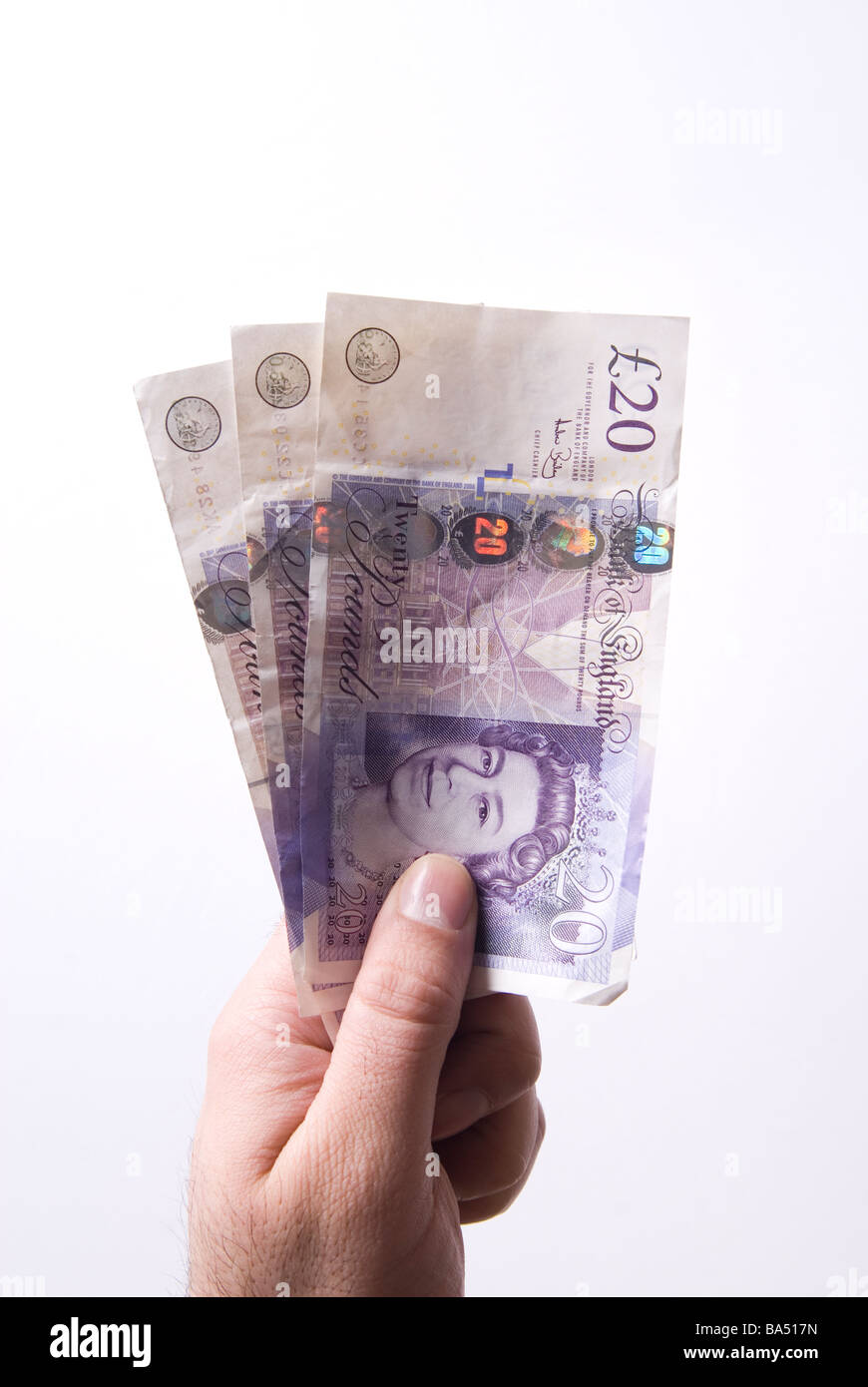 Hand holding British Money against a white background Stock Photo - Alamy