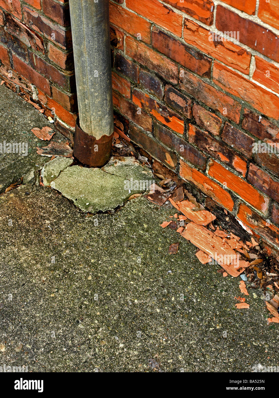 water drain drainpipe running down the side of a brick building with ...