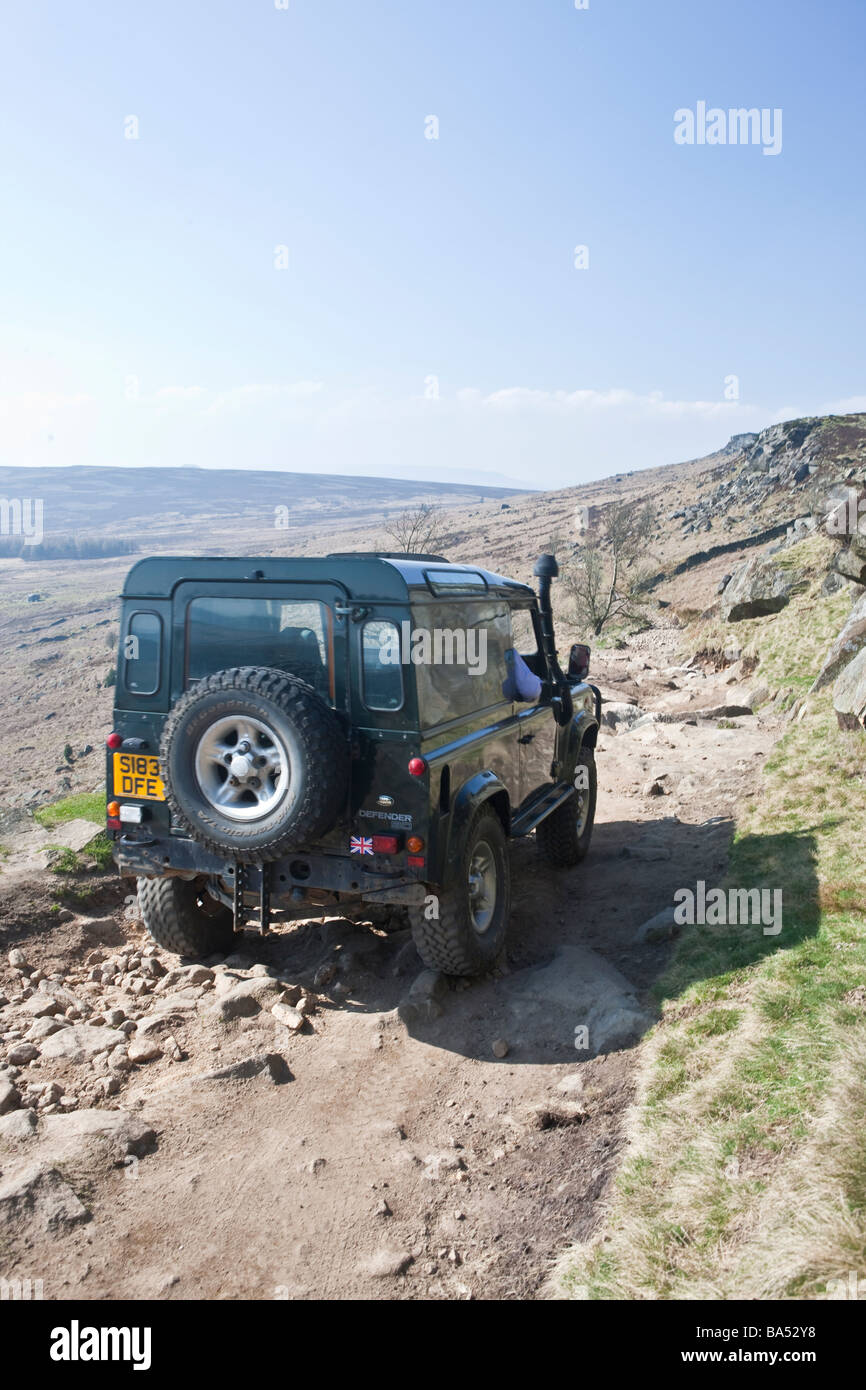 land rover defender descends the track down stanage edge in the ...