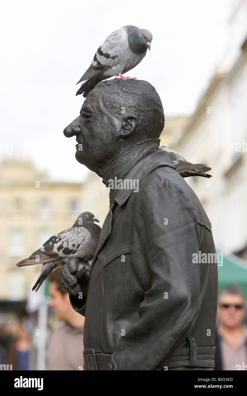A street performer dressed up as human statue stands in a street in ...