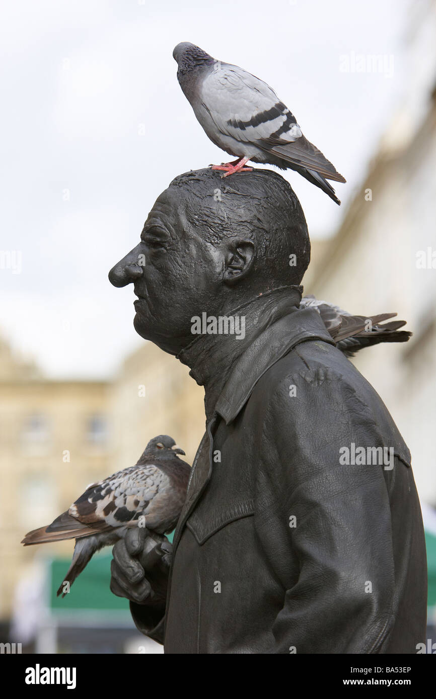 A street performer dressed up as human statue stands in a street in ...
