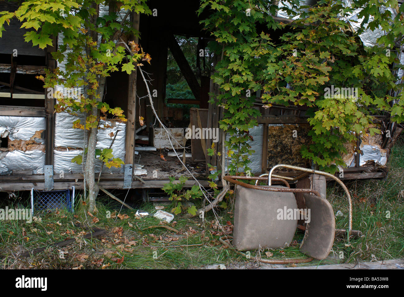 Old abandoned house trailer mobil home in green nature overhead from ...