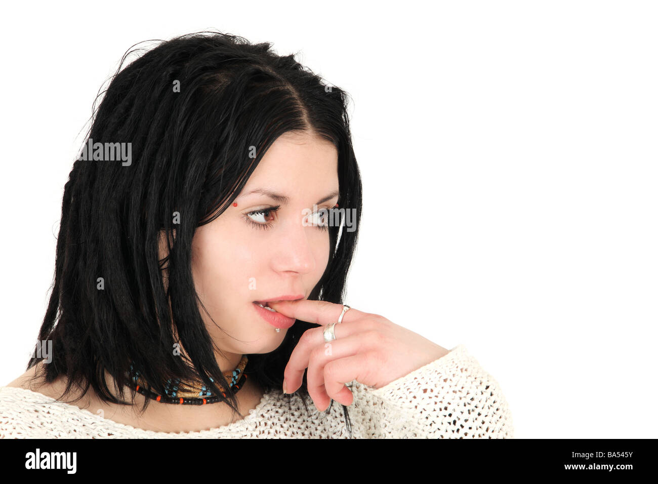 Portrait of teenage girl biting her finger, studio shot Stock Photo - Alamy