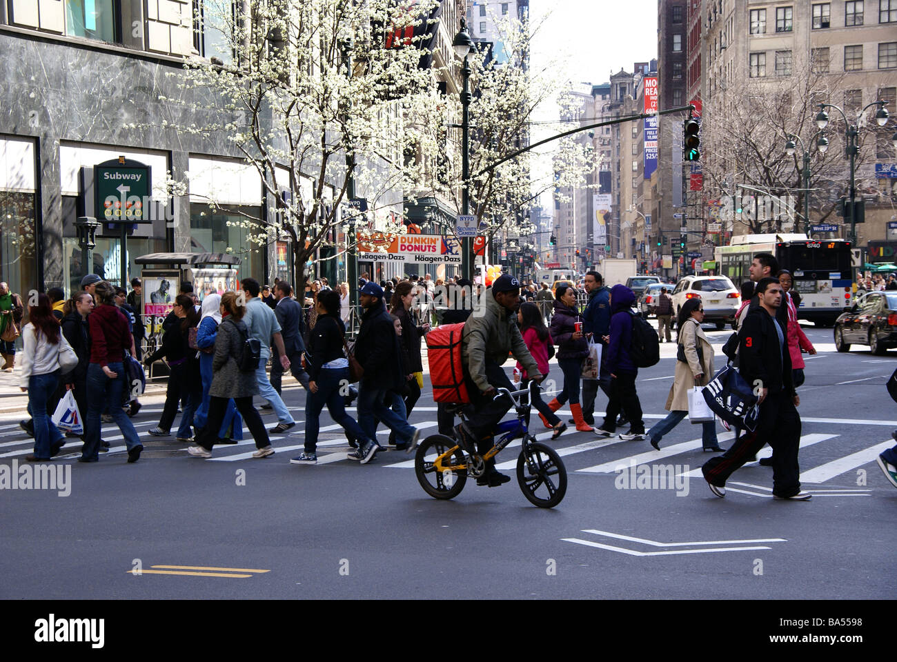 Messenger on a bike on 34th street in Manhattan Stock Photo - Alamy