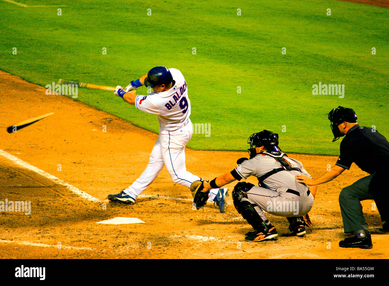 Major league baseball players compete during a night game at Arlington ...