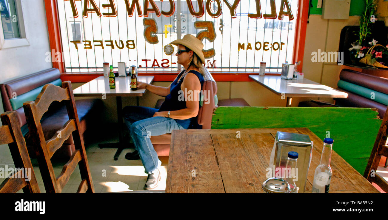 Woman with western cowboy hat outside of a Mexican "all you can eat ...