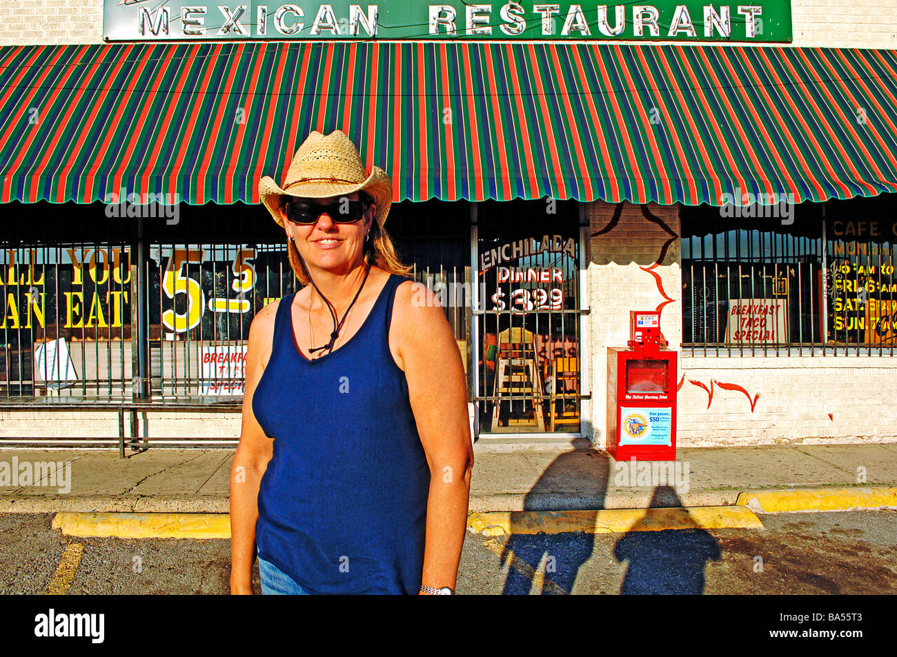 Woman with western cowboy hat outside of a Mexican "all you can eat ...
