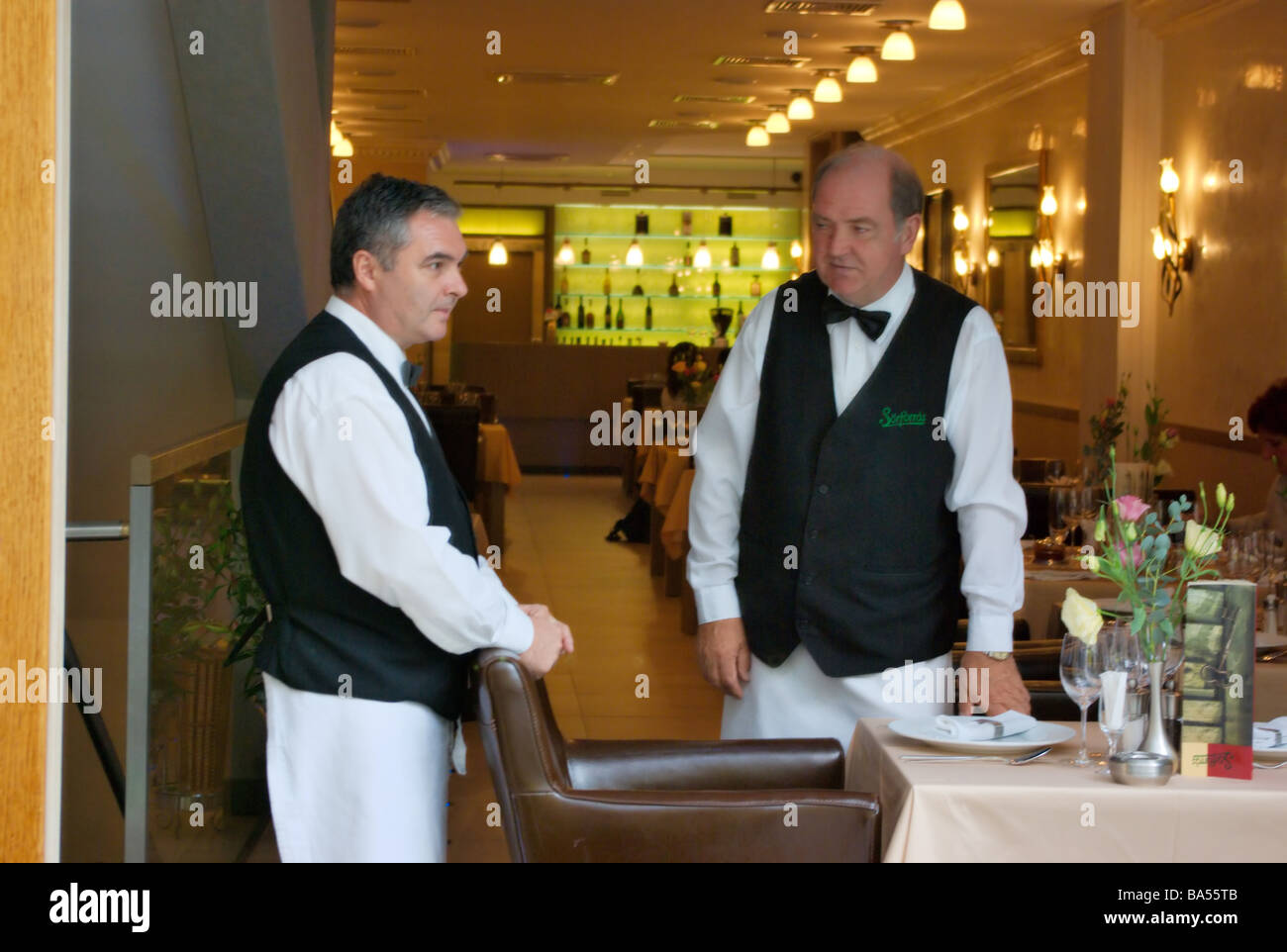 Two waiters waiting Stock Photo - Alamy