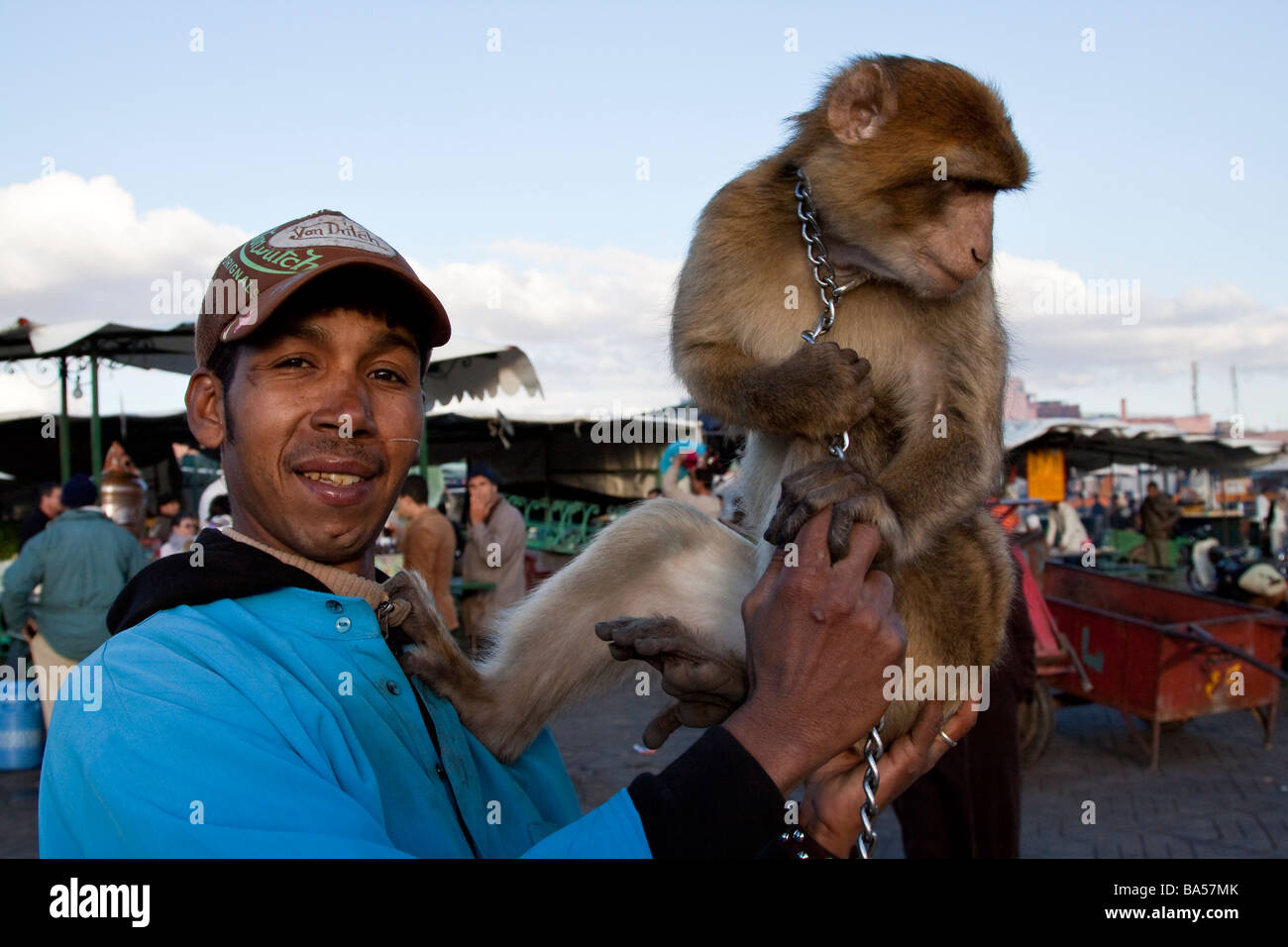 Local Moroccan men with tame pet monkeys pose for photographs on the ...