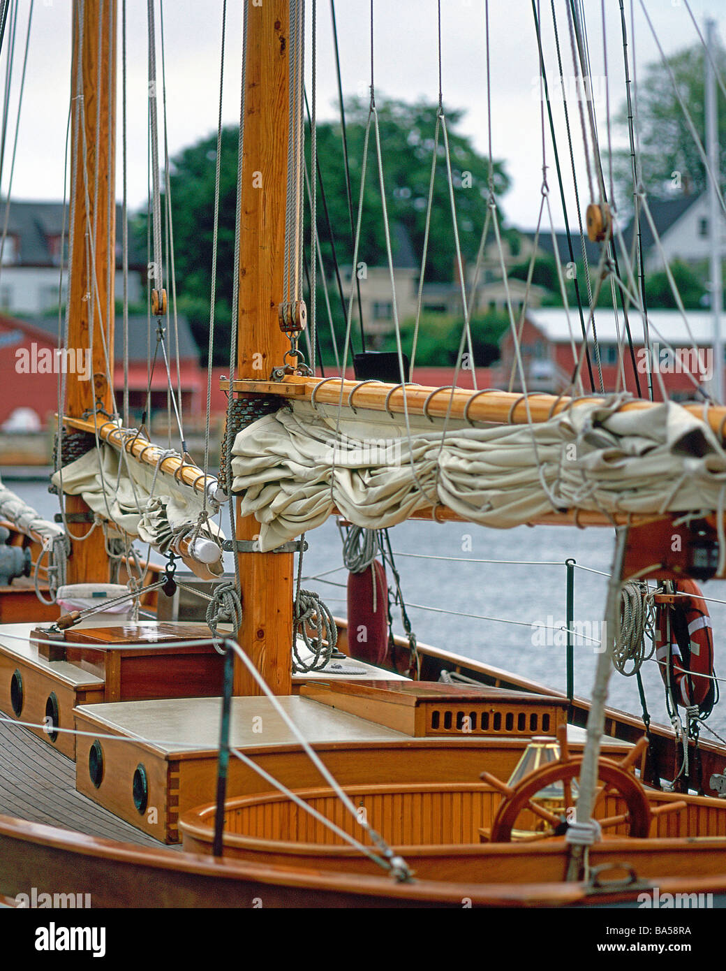 Wood sailboat with sails tied down Stock Photo - Alamy