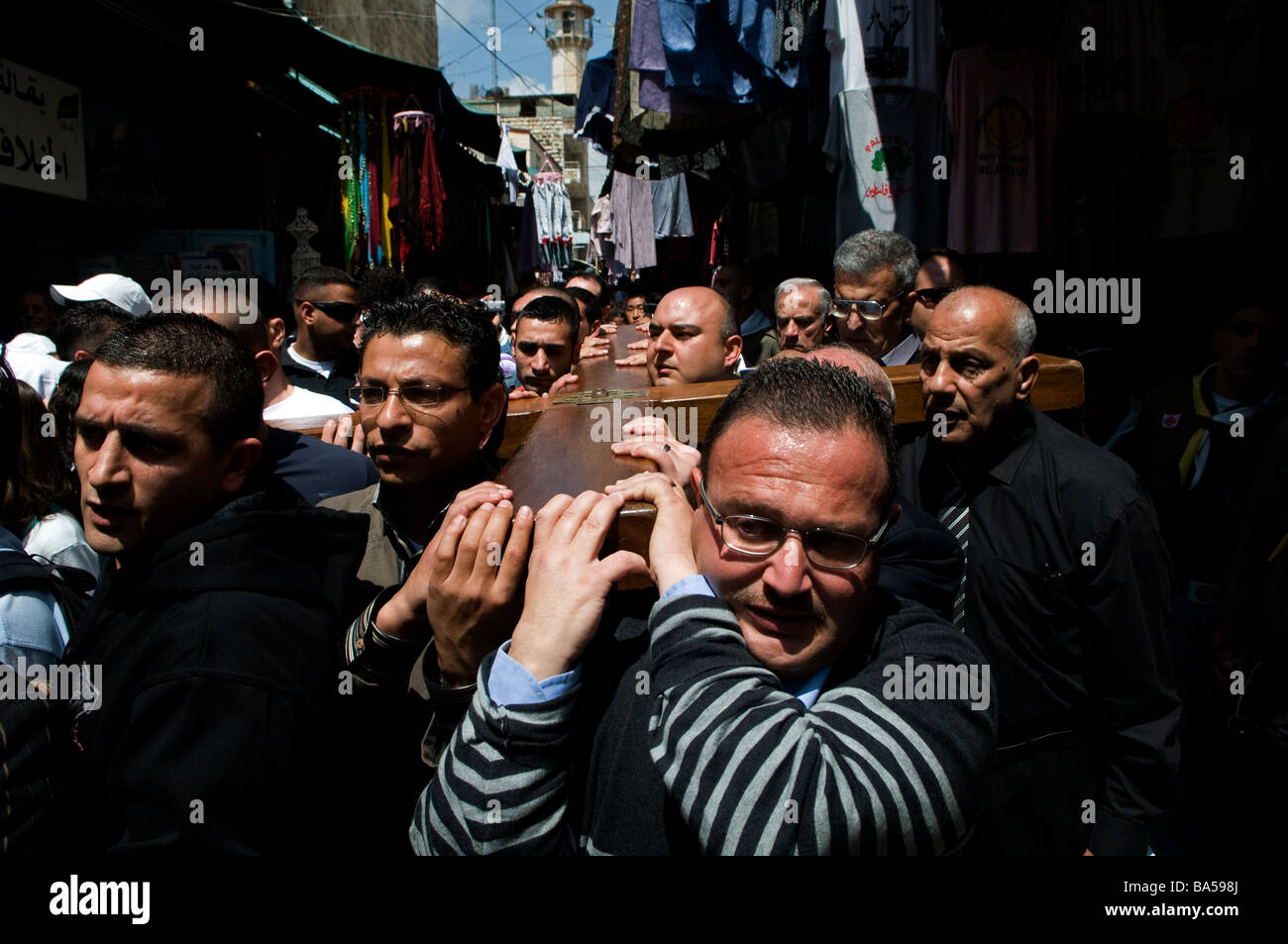 Christian Arab pilgrims carry a large Crucifix along Via Dolorosa ...