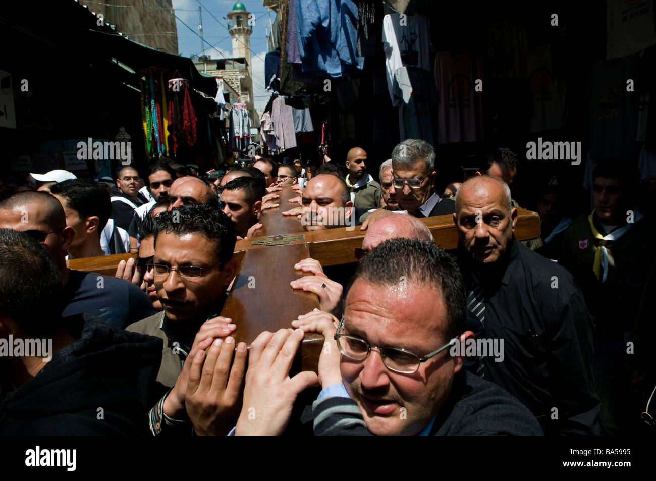 Christian Arab worshipers carry a large Crucifix along Via Dolorosa ...
