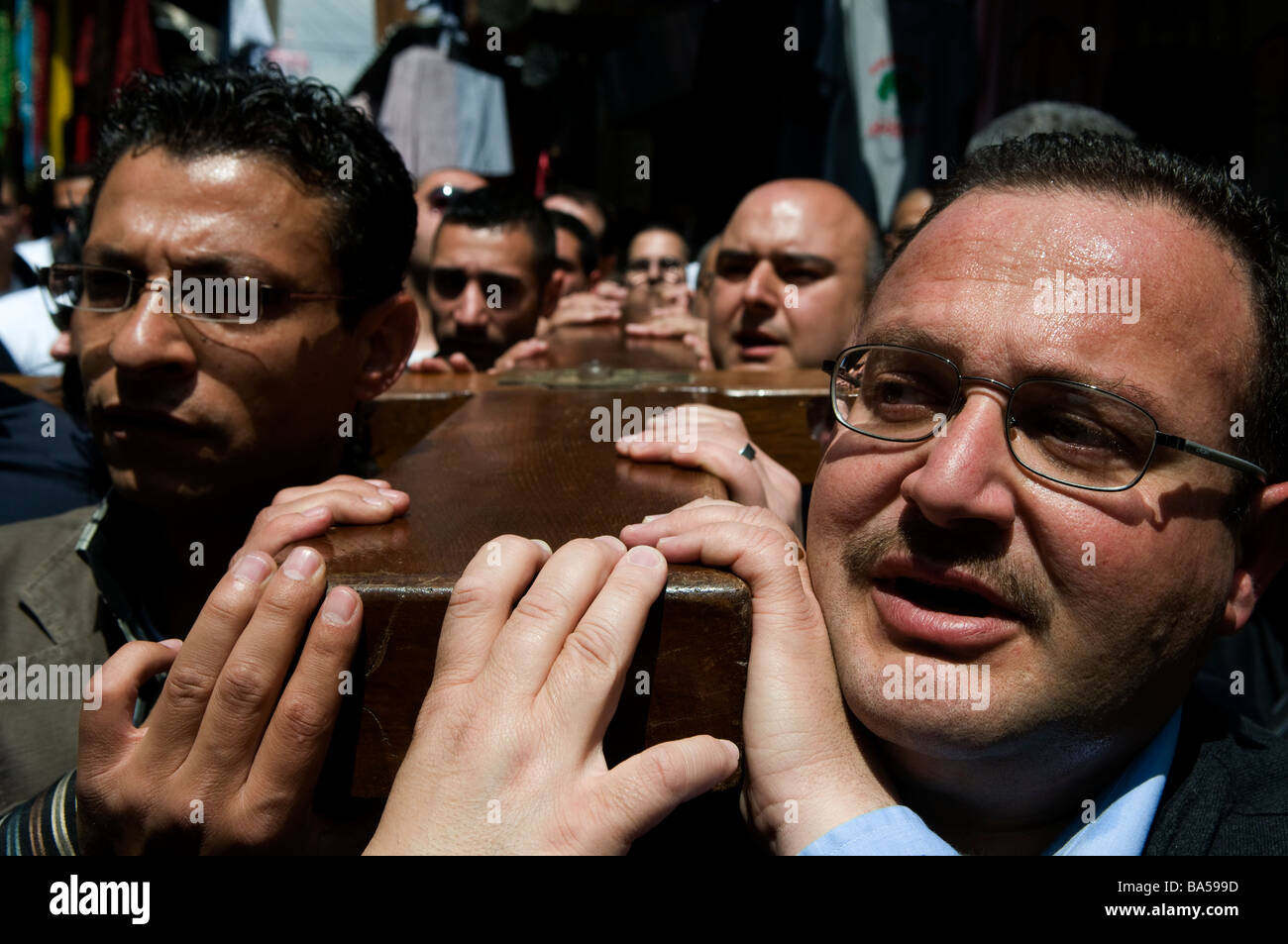 Christian Arab pilgrims carry a large Crucifix along Via Dolorosa ...
