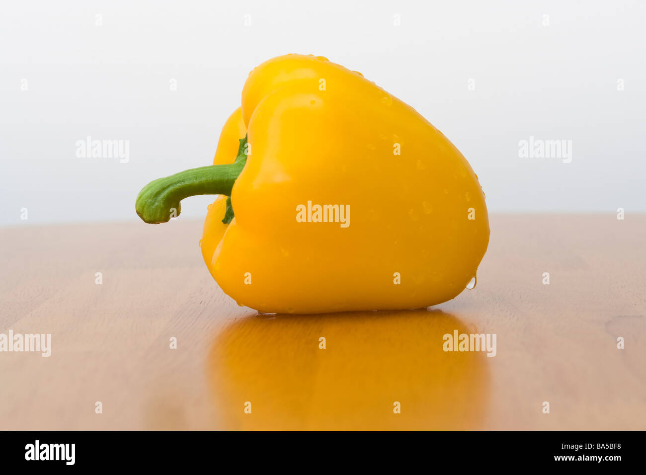 Yellow pepper on a kitchen table Stock Photo - Alamy