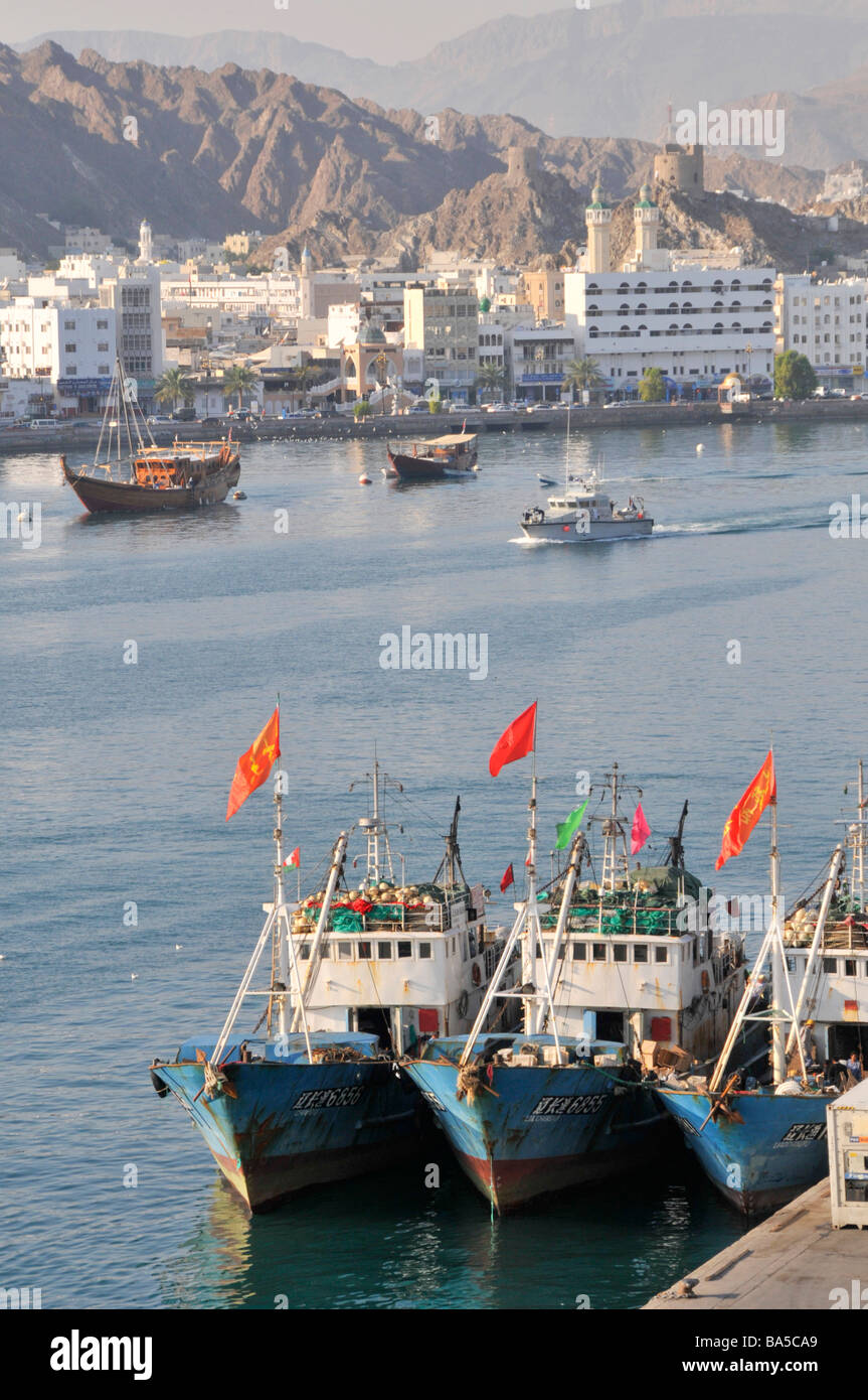 Waterfront and three fishing boats moored at Port Sultan Qaboos at ...