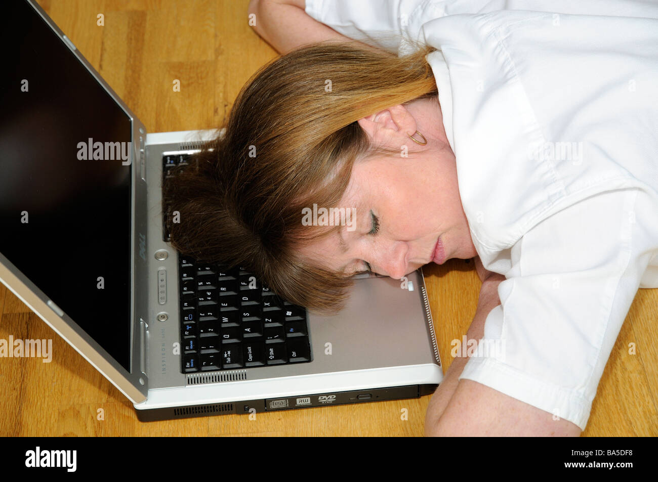 Woman sleeping on keyboard of laptop computer Stock Photo - Alamy