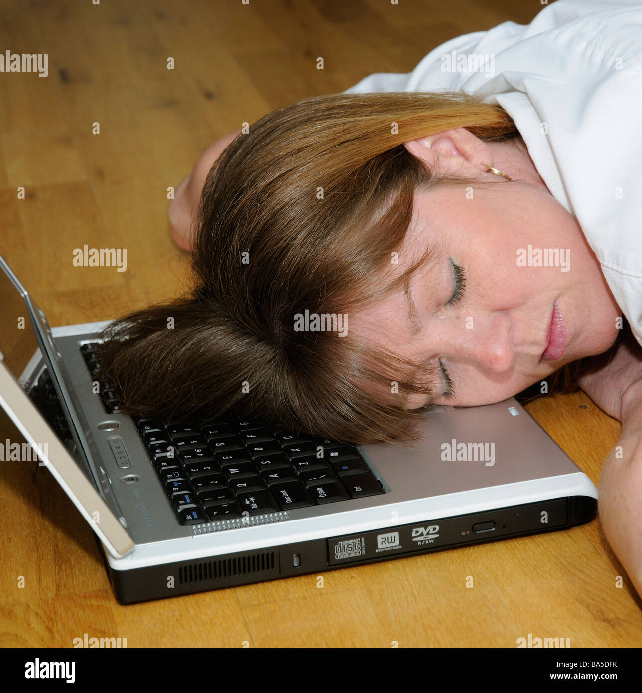 Woman sleeping on keyboard of laptop computer Stock Photo - Alamy