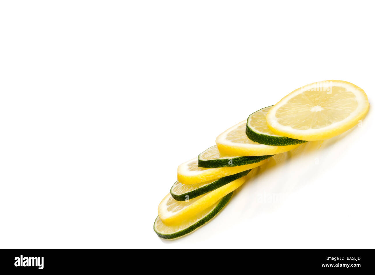 A tilted horizontal close up of juicy fresh cut lemon and lime slices ...