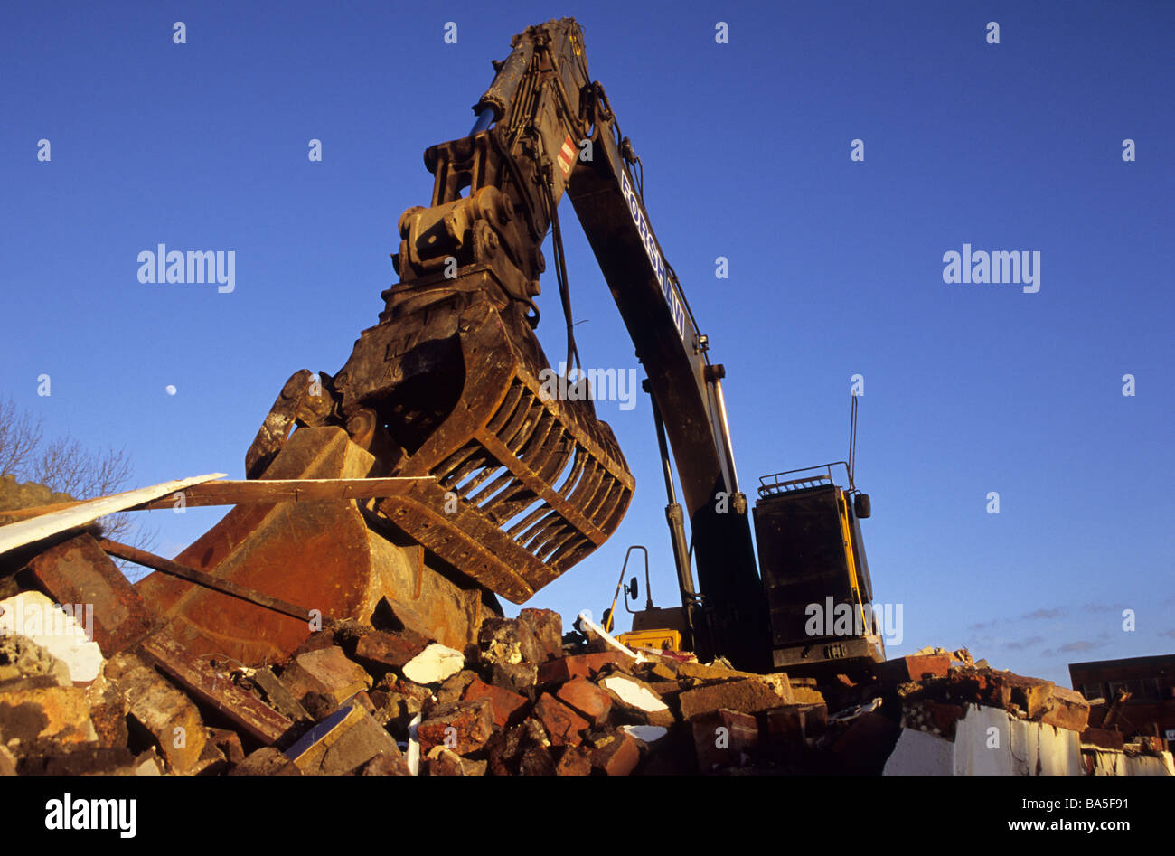 Grabber Machine Removing Old Bricks And Rubble Stock Photo - Alamy