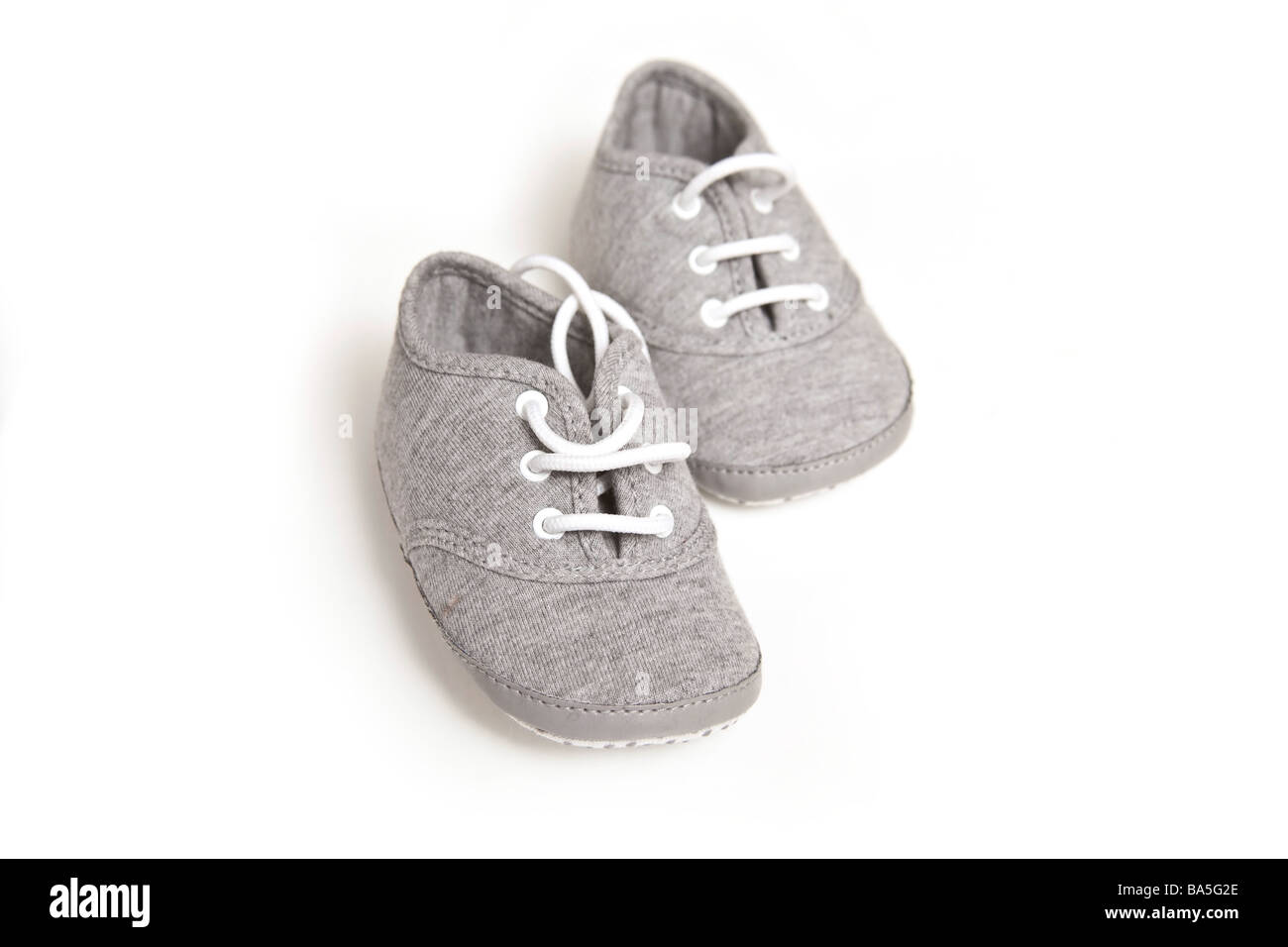 Babies shoes isolated on a white studio background Stock Photo - Alamy