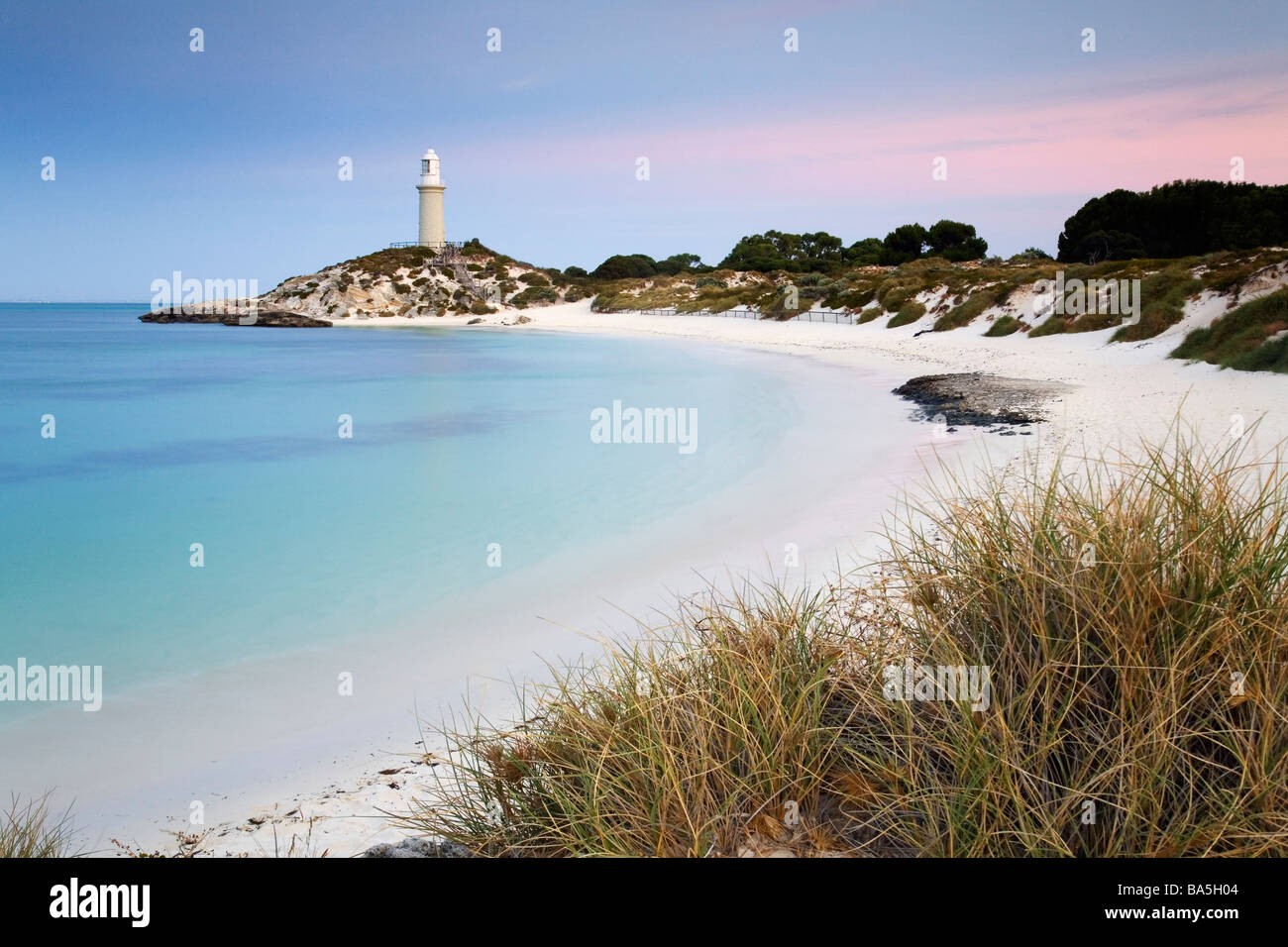 View along Pinky Beach to Bathurst lighthouse at dusk. Rottnest Island ...