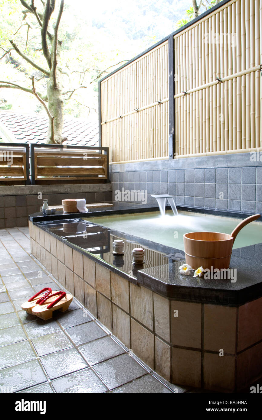 Pool with ladle on the edge clogs aside Stock Photo - Alamy