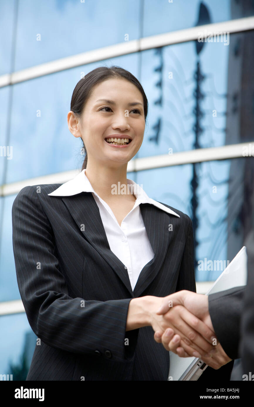 Portrait of businesswoman shaking hands with man smiling Stock Photo ... Portrait of businesswoman shaking hands with man smiling Stock Photo ...