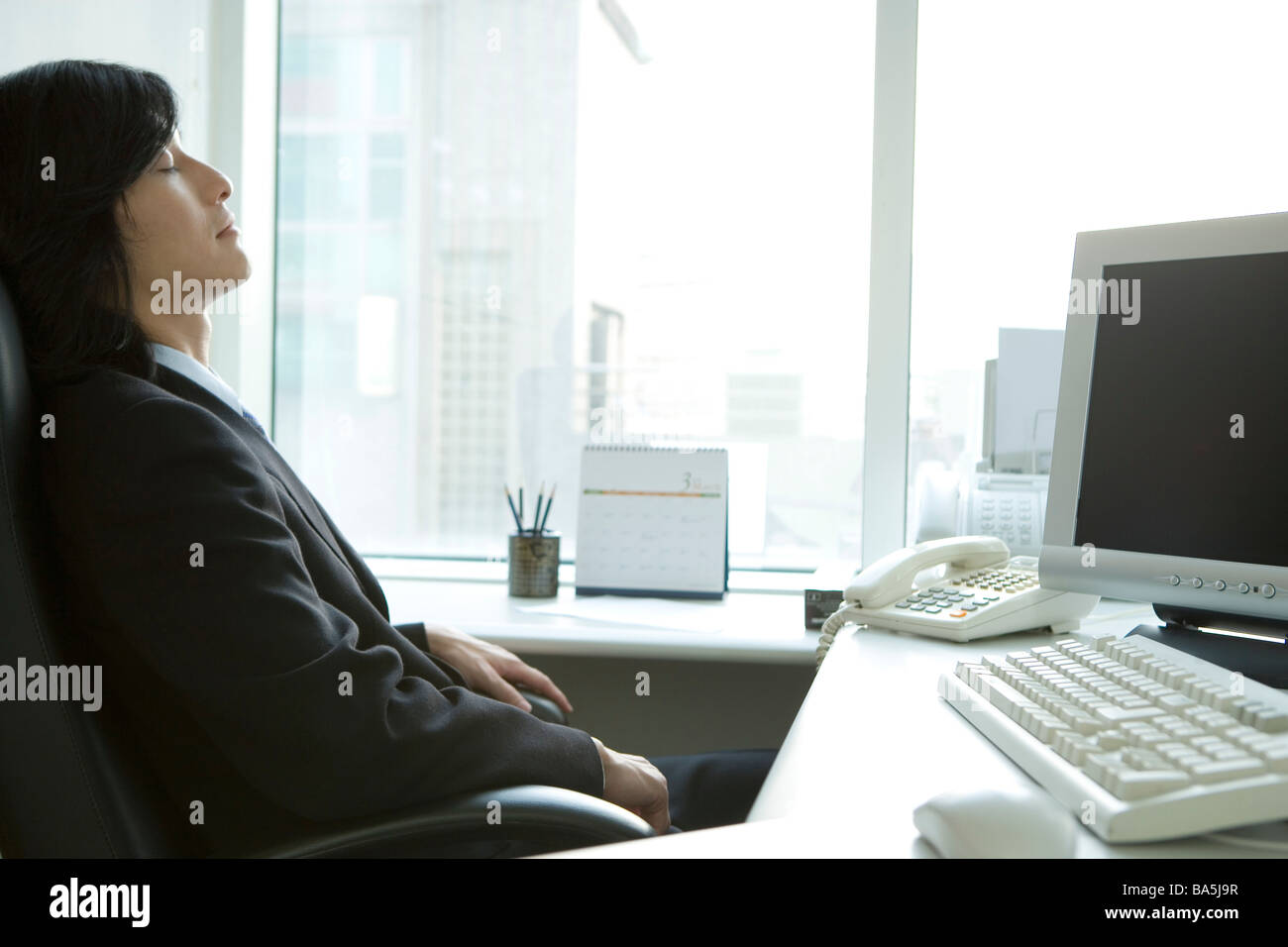 Asian businessman meditating sitting desk hi-res stock photography and ...