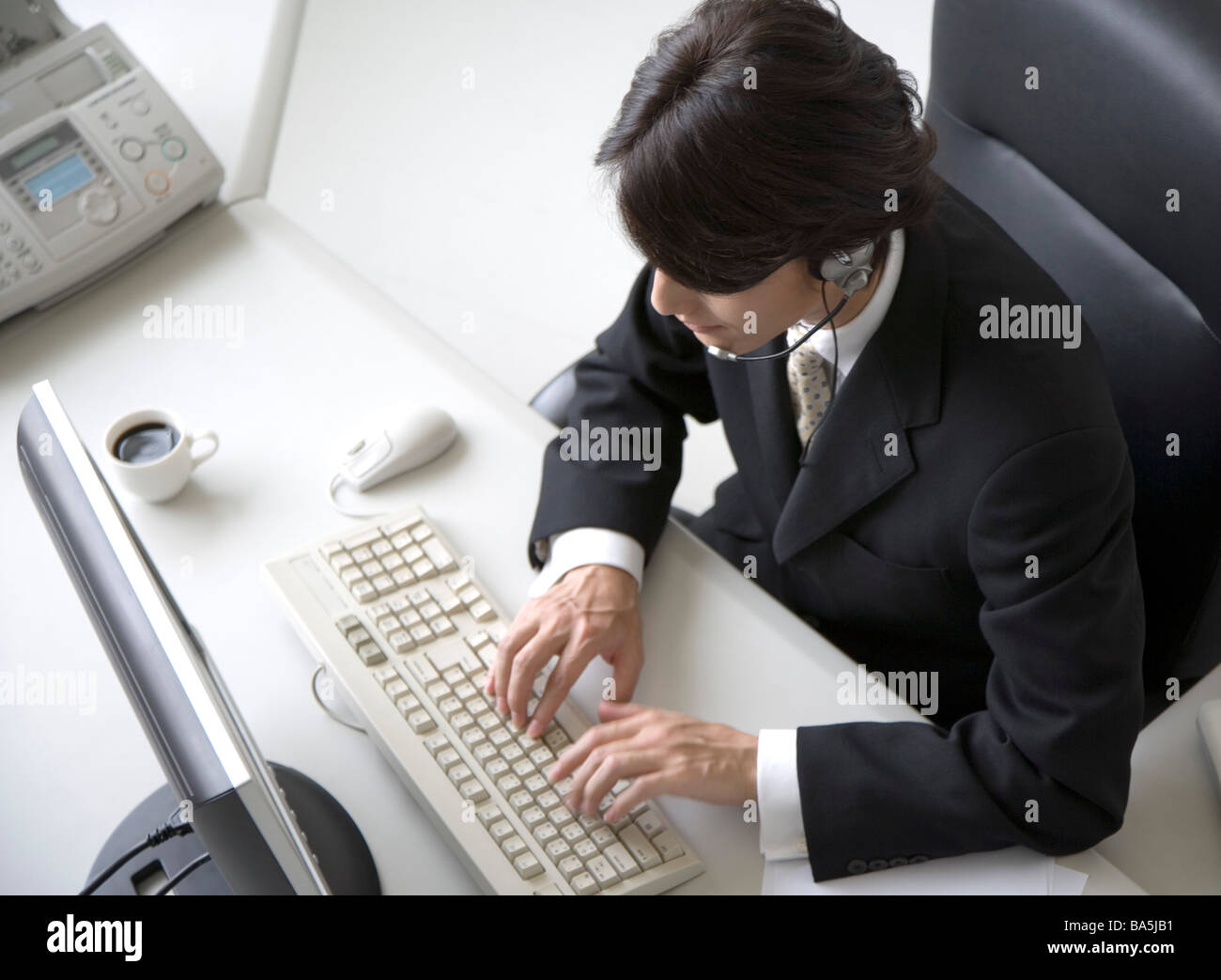 Overhead view of businessman typing at desk Stock Photo - Alamy