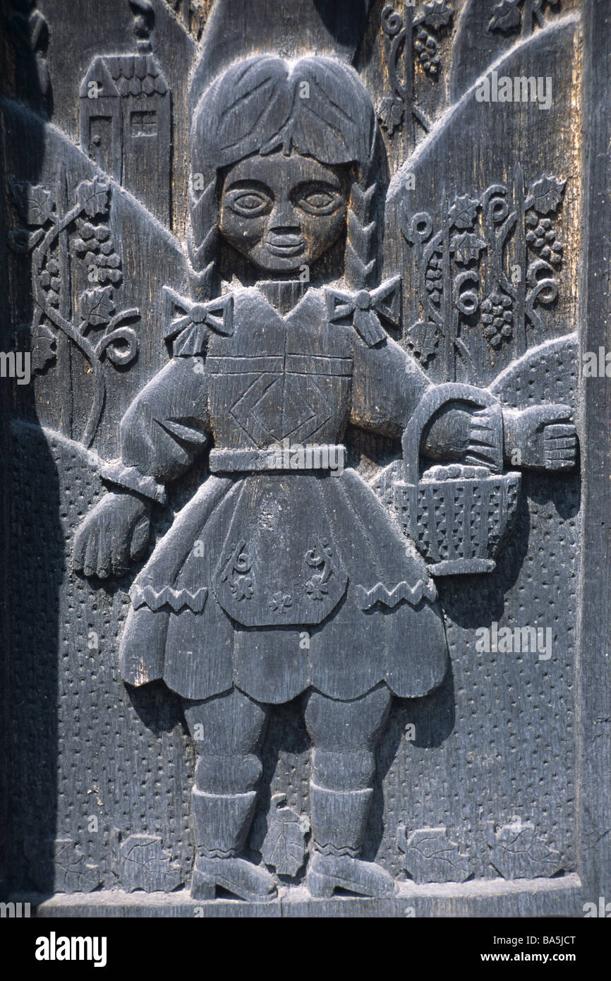 Relief Carving of Wooden Folk Art Figure of Girl Carrying Basket on ...