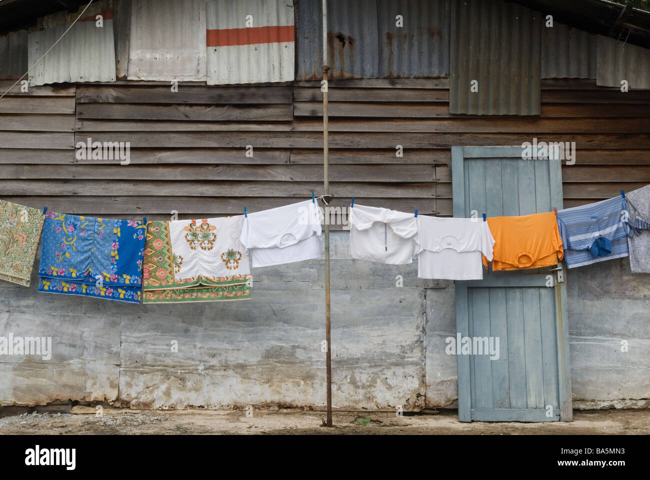 Washing hung out to dry on a line outside a wooden house in Malacca ...
